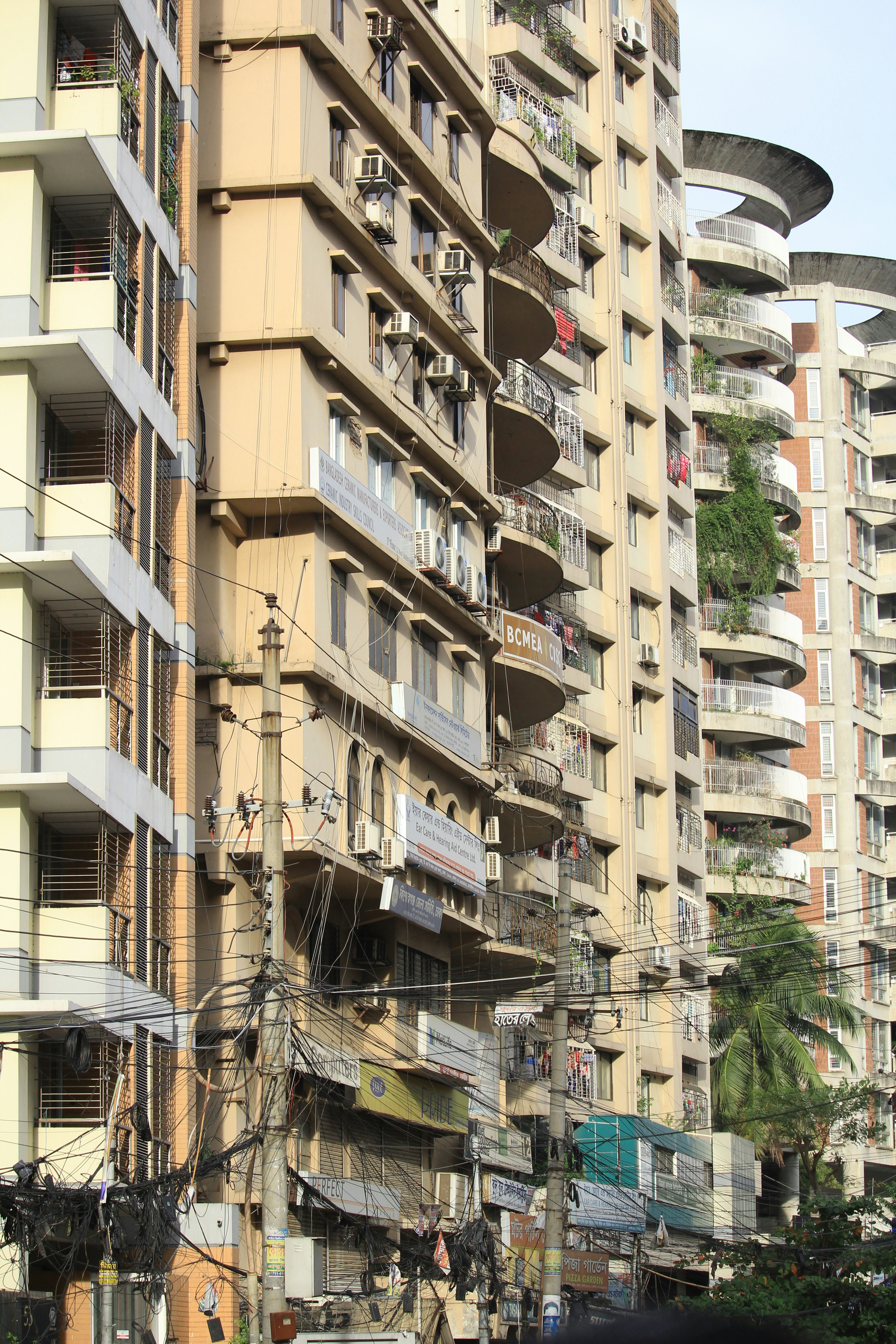 Vertical Cityscape: Balconies, Wires, and Weathered Facades