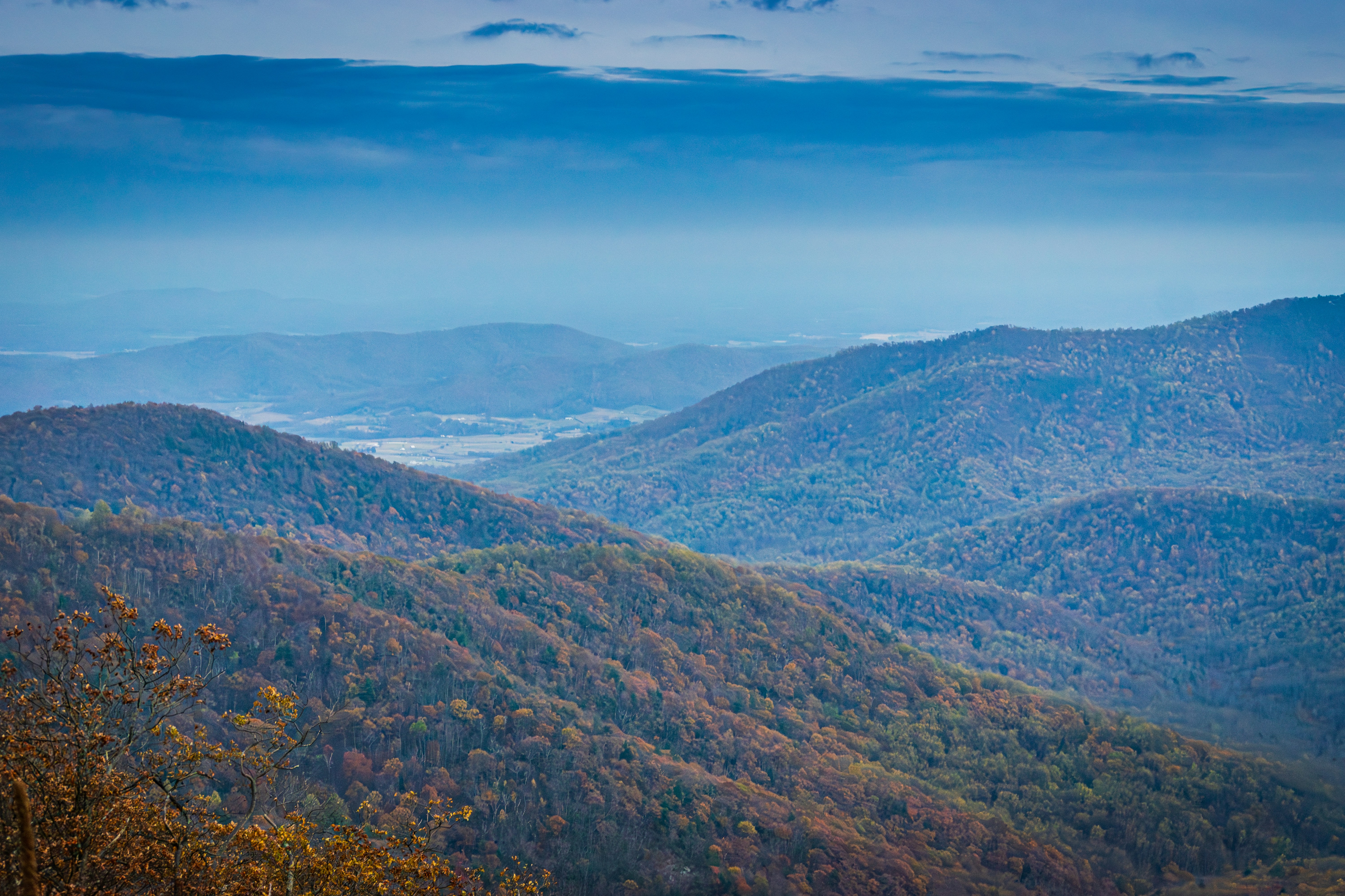 Autumn Valleys: A Corridor of Hills Under a Quiet Horizon