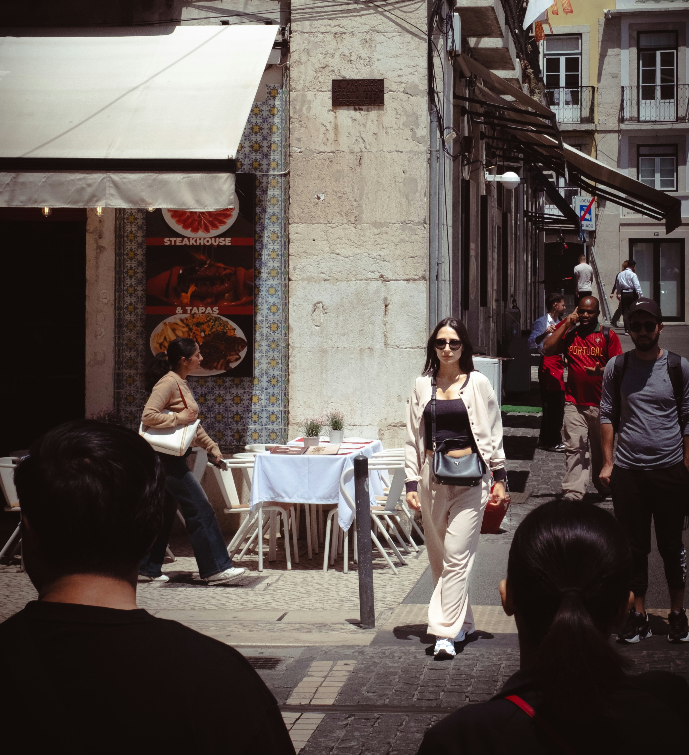 City Walk: A Stylish Stranger Amid a Stone-Faced Street