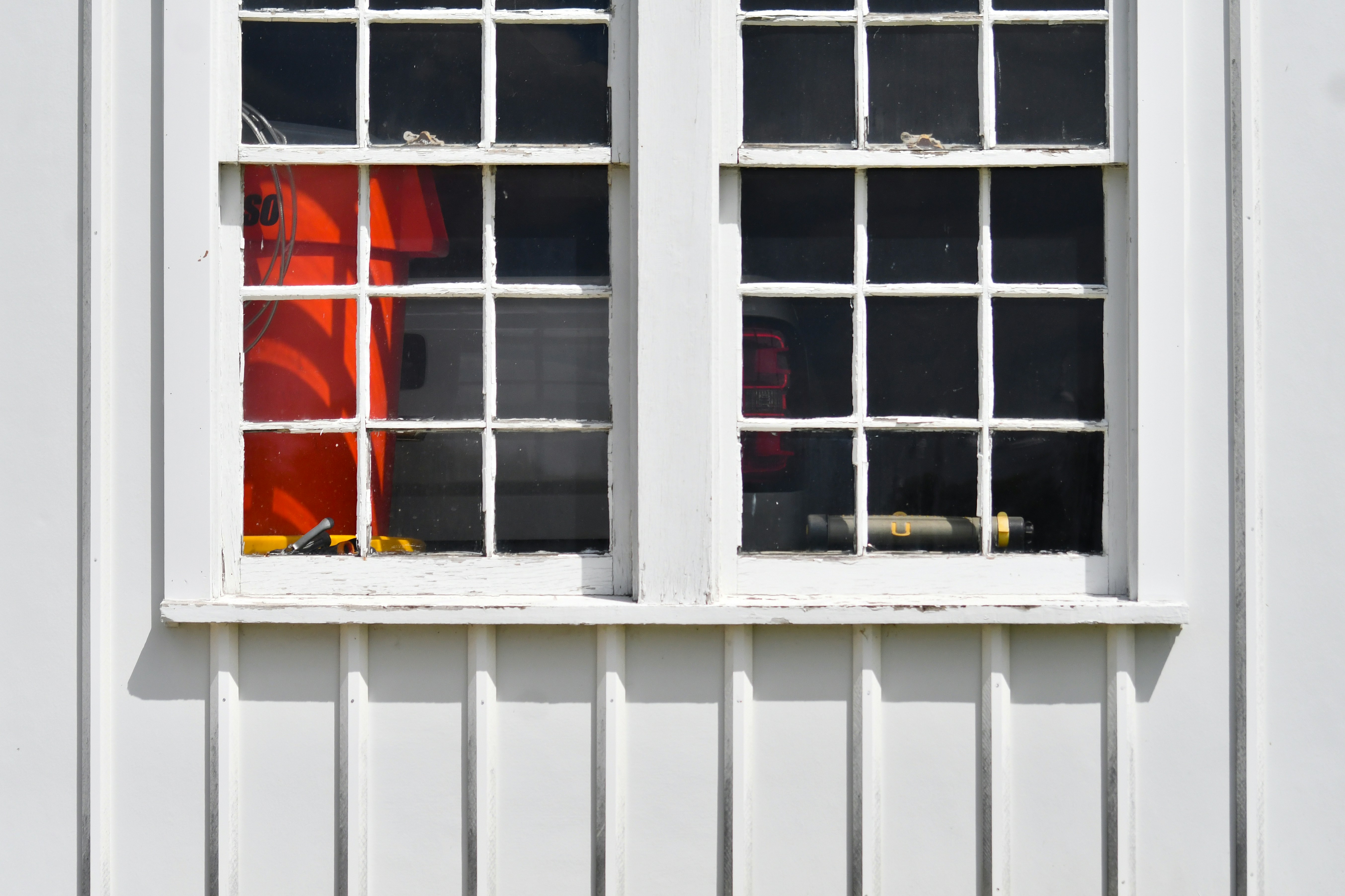 Windowpanes and Painted Wood: A Quiet Exterior View