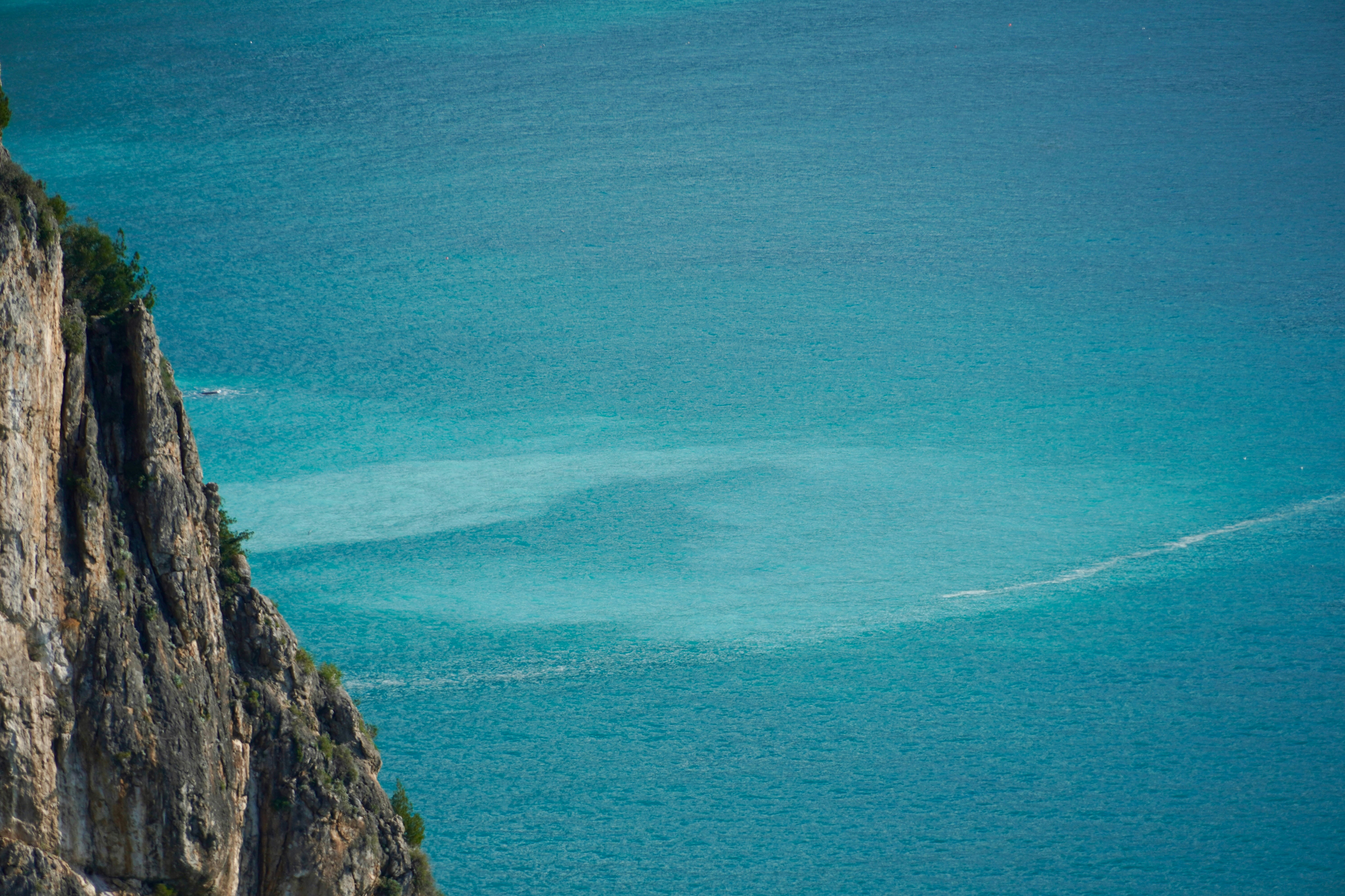 Cliffside Edge Over Aquamarine Waters