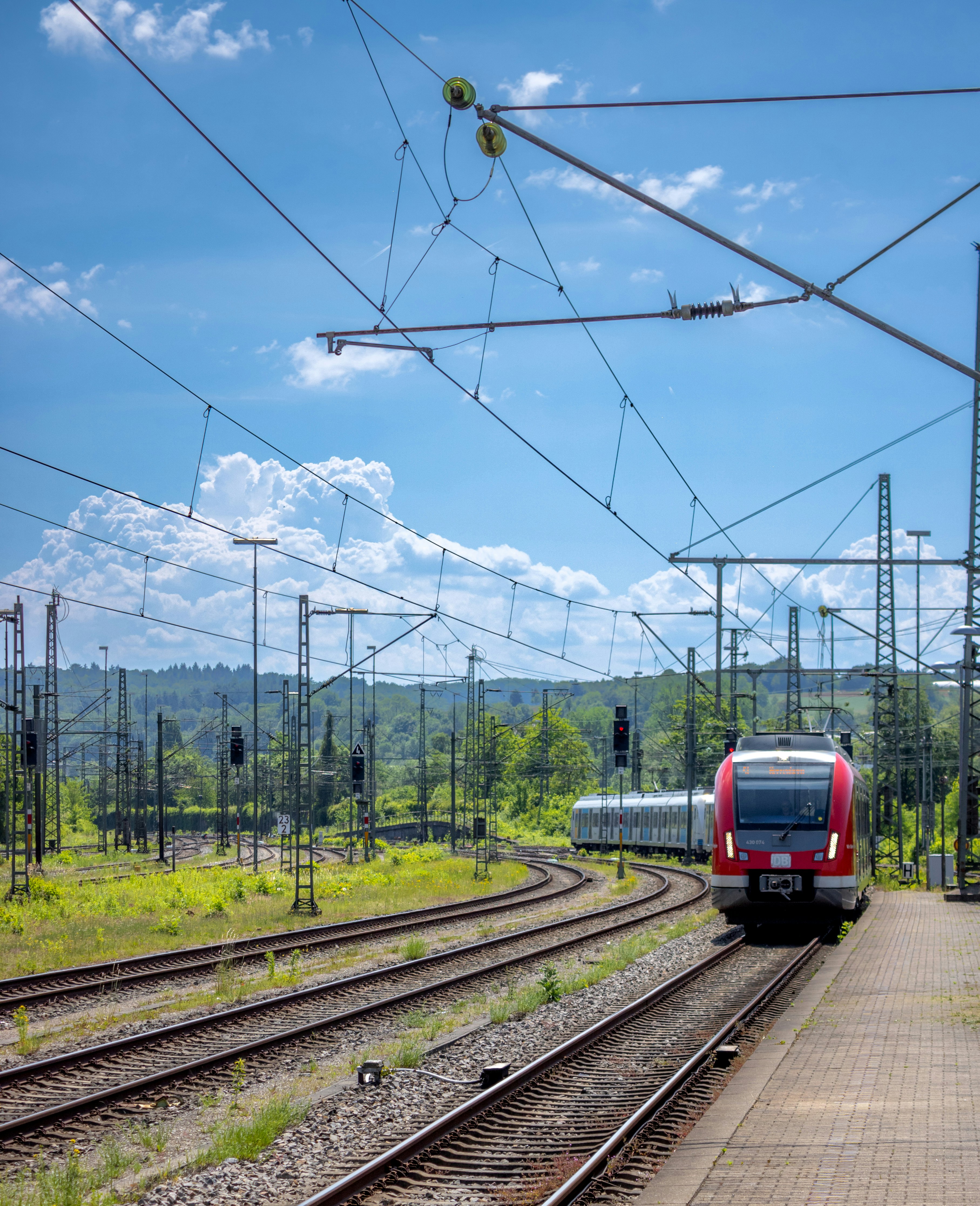 Red Comet on the Tracks: A Modern Train Beneath a Web of Cables
