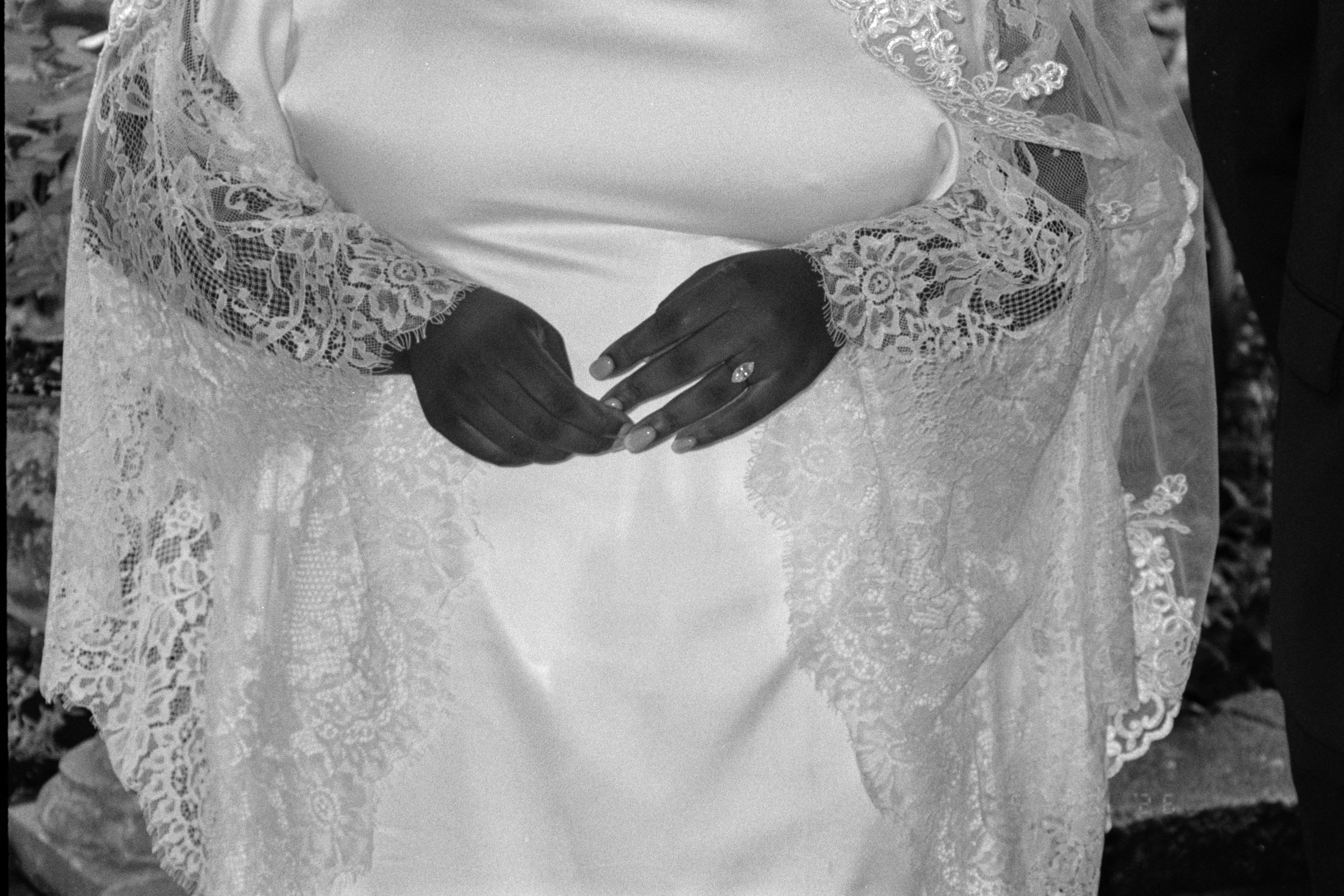 Hands Folded in Lace: A Nuptial Moment in Monochrome