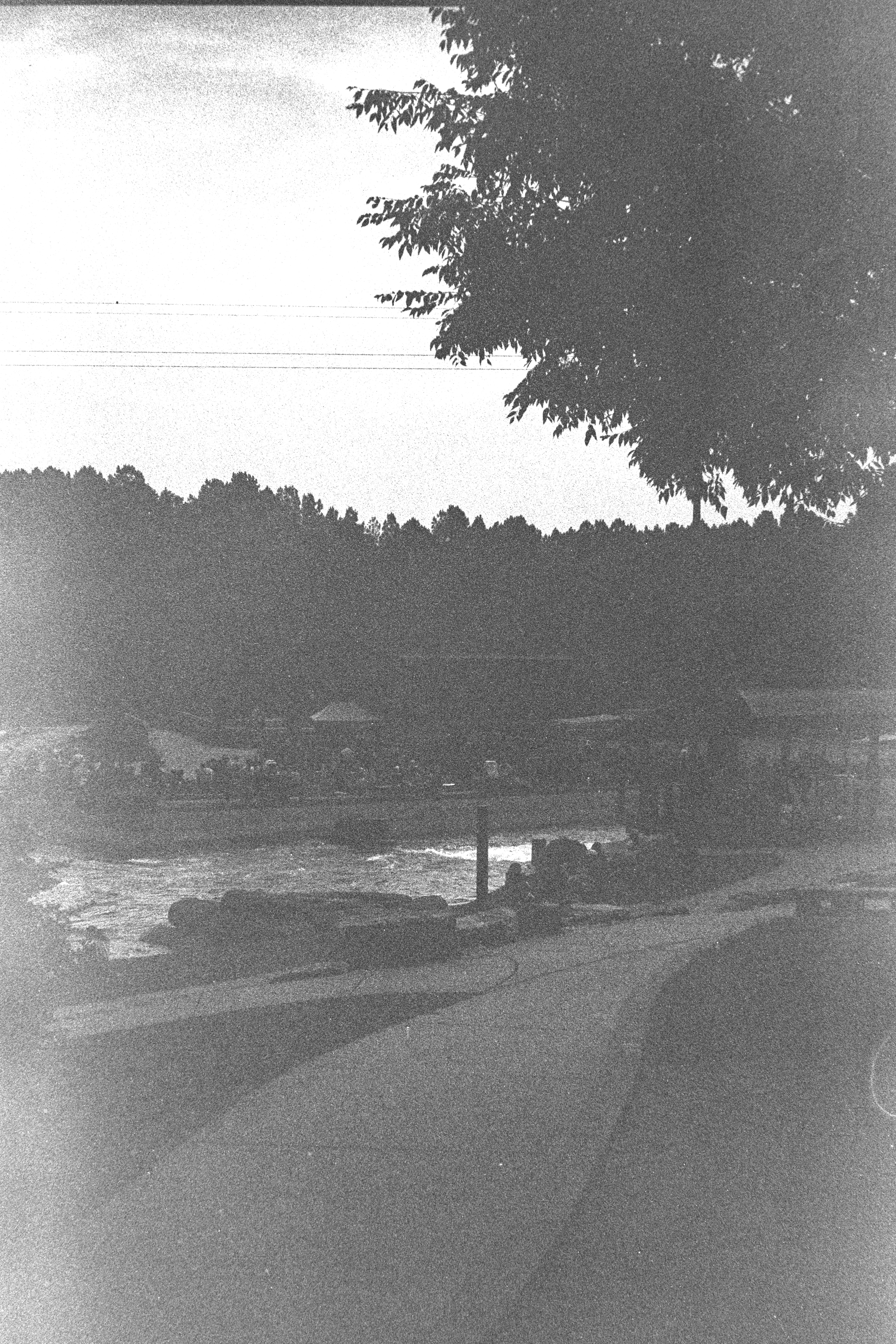 Riverbank Quietude: A Grainy Evening by the Docks