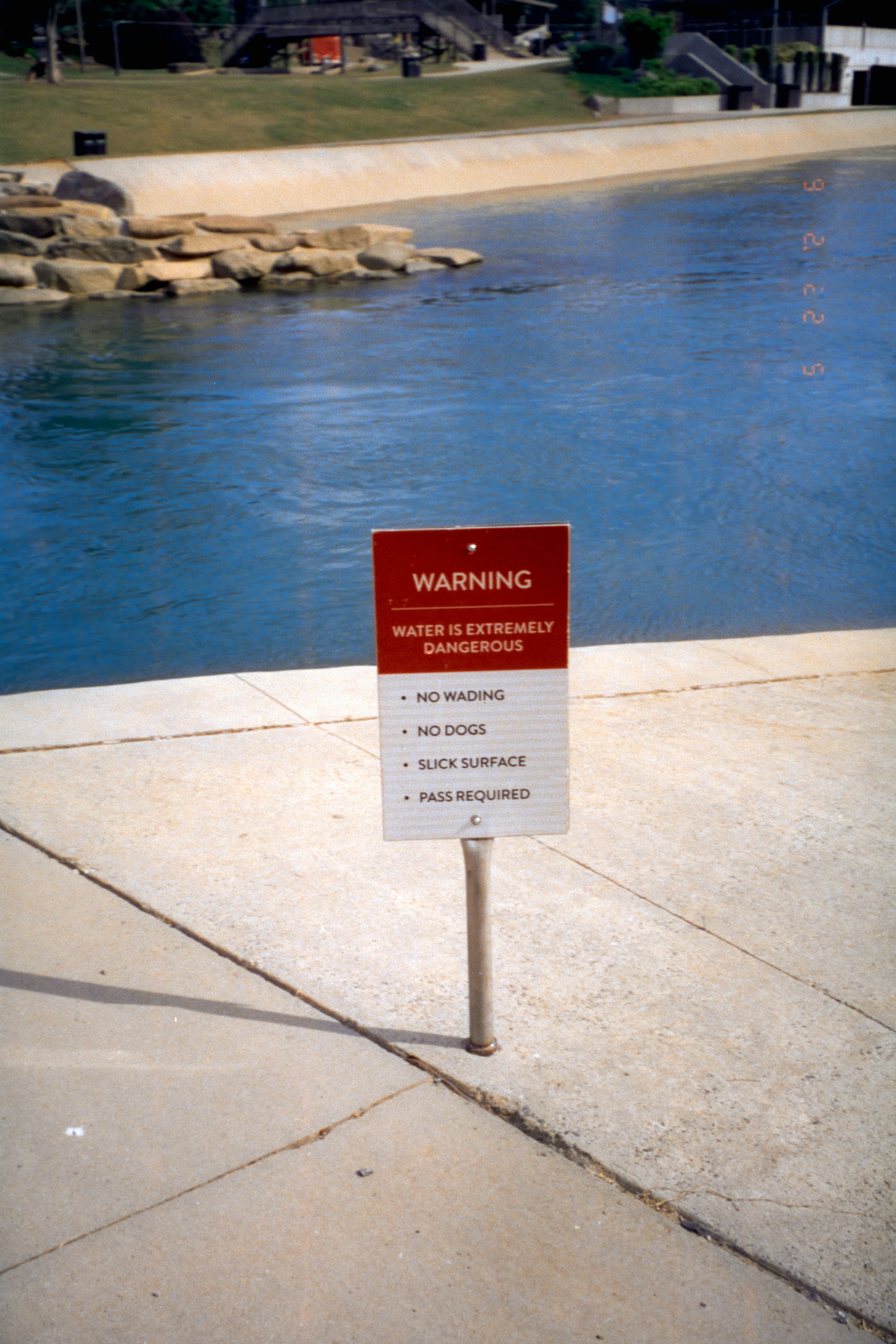 Red Warning Sign by the Calm Pool