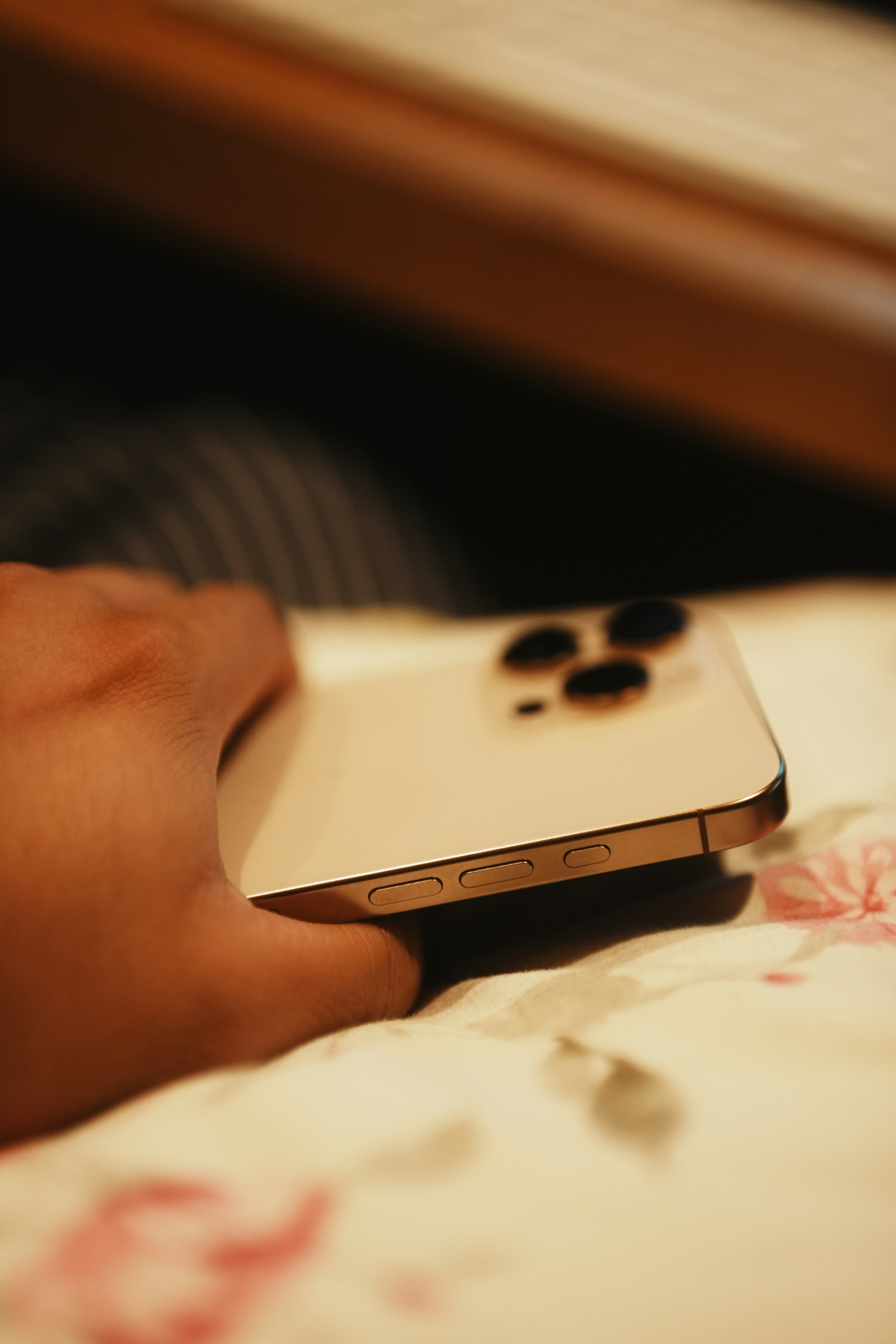 Gold Edge: A Quiet Moment with a Hand-Held Phone on a Bed