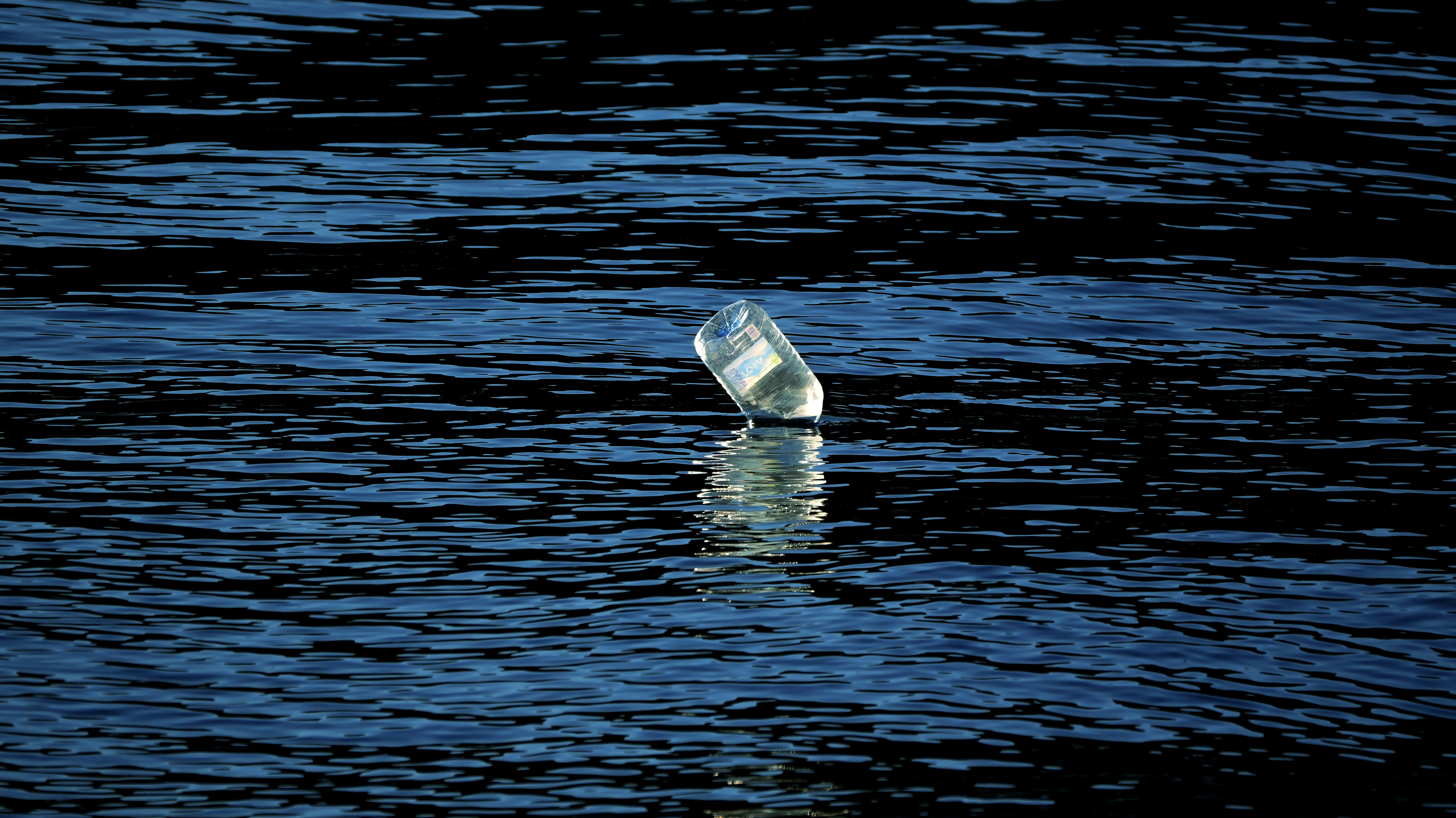 Floating Glass: A Single Ice Fragment on Quiet Evening Waters