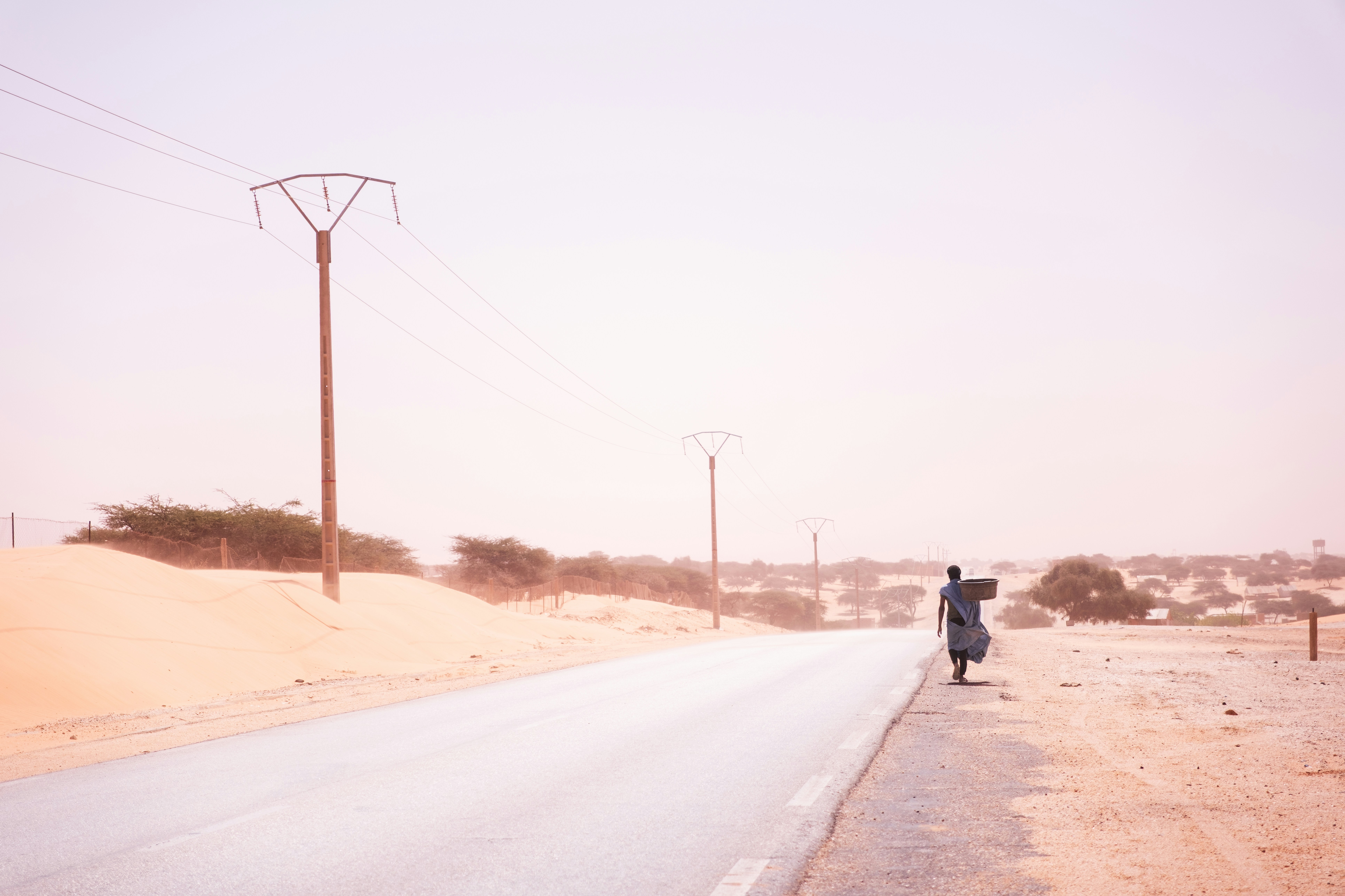Desert Road with a Lone Messenger under Quiet Sky