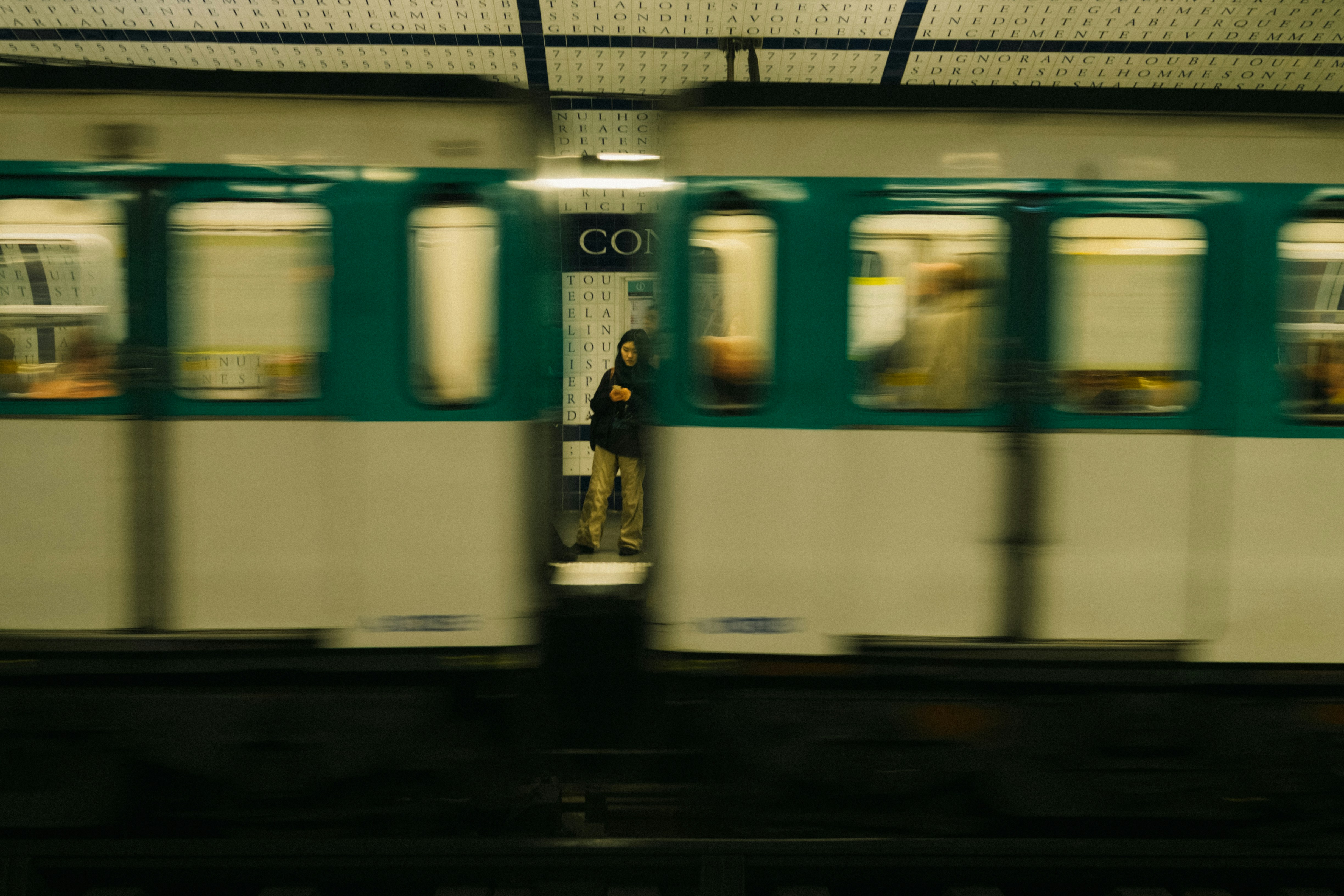 Standby at the Subway: A Passenger Pauses on a Blurred Platform