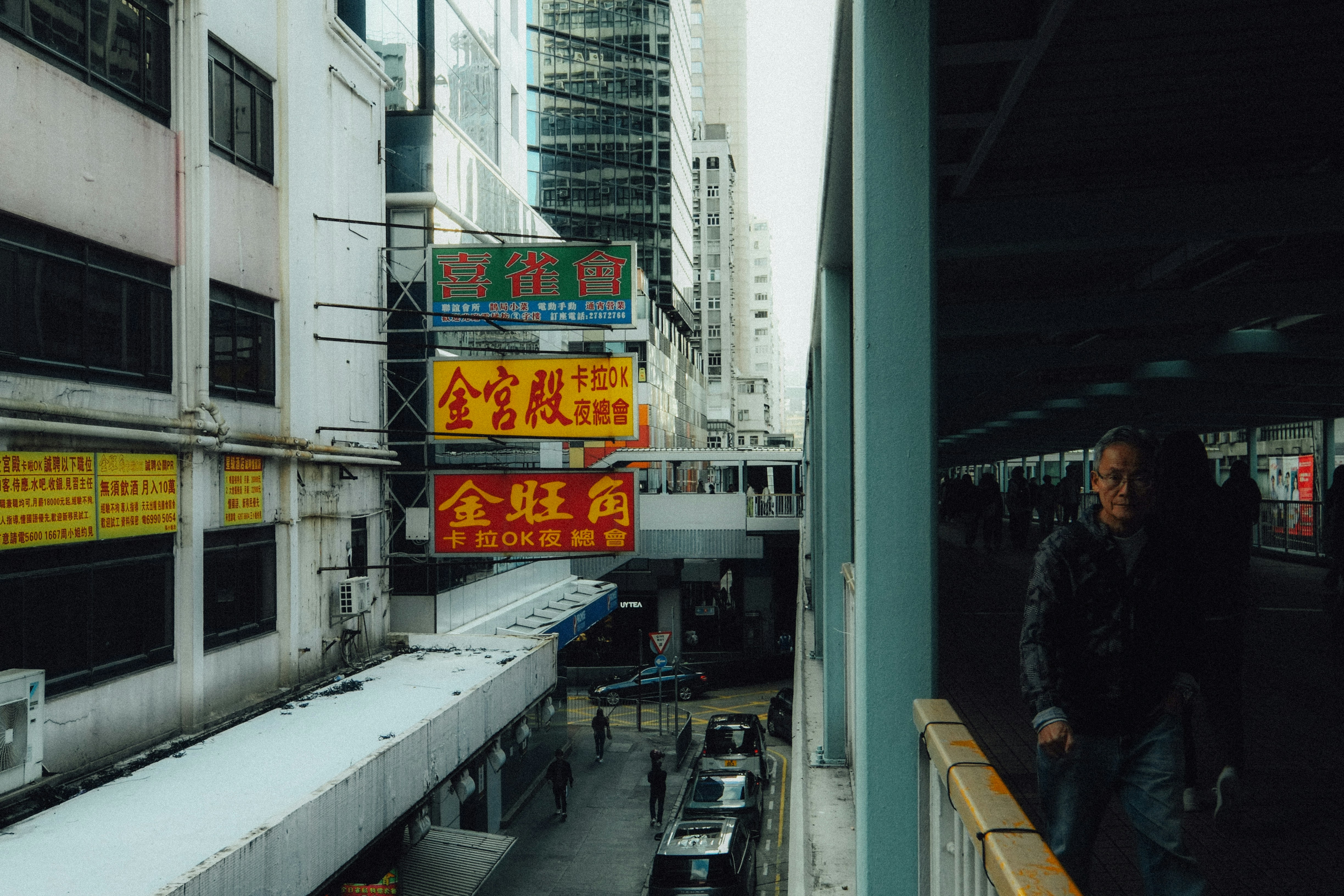 Neon Signs Overlooking a City Walkway