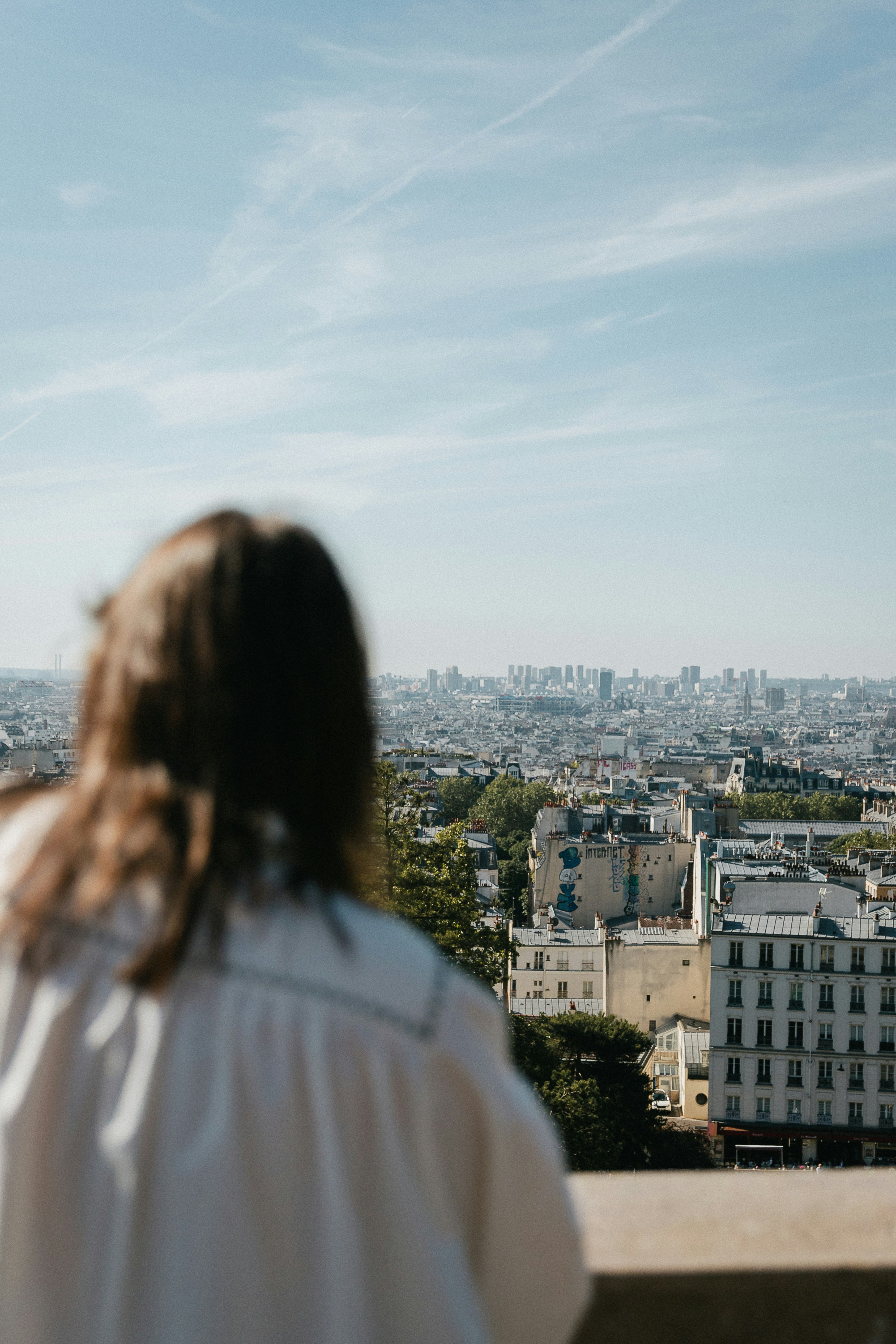 City overlook: silhouette of a traveler framed by a rising skyline