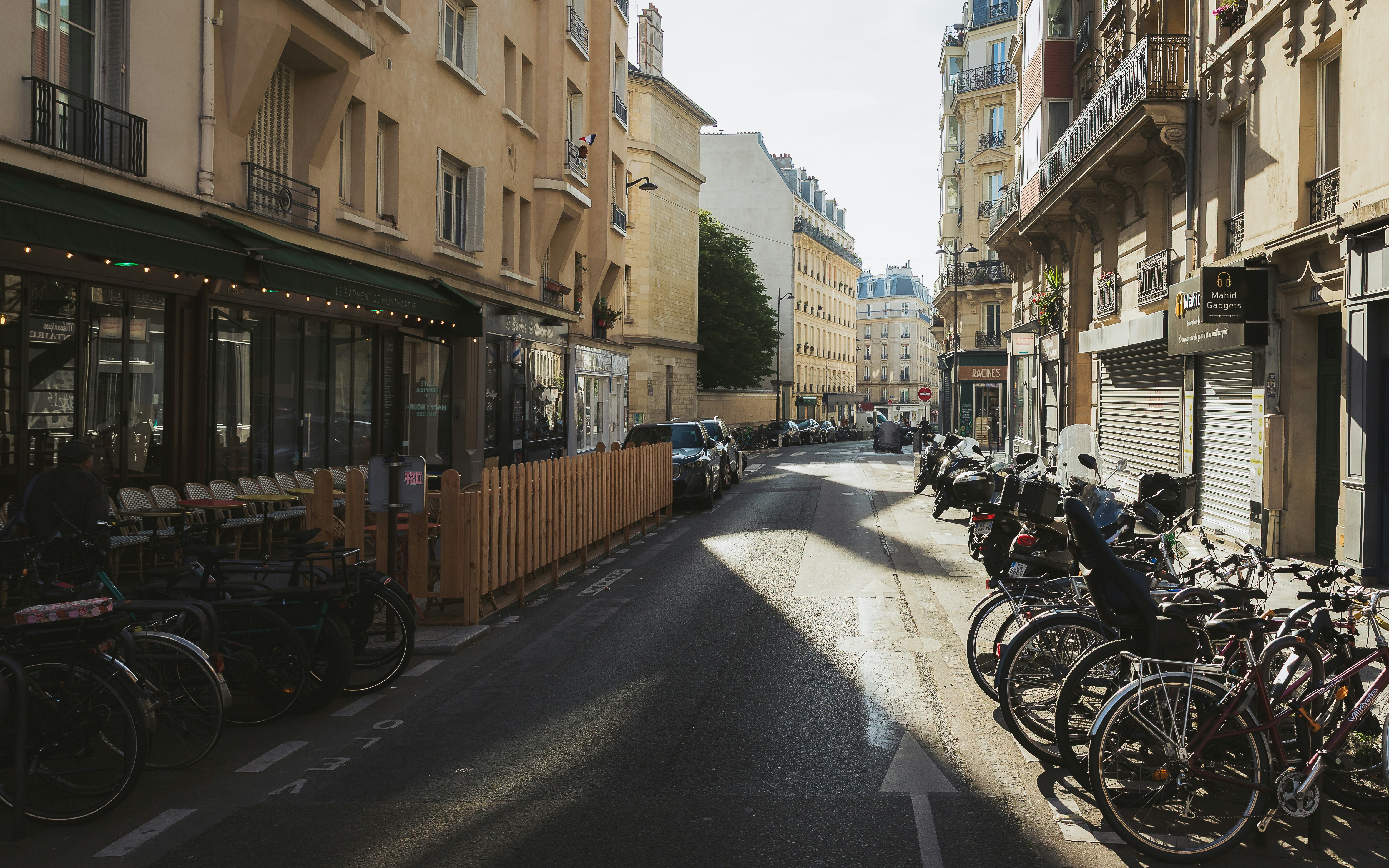 Sunlit City Street Amid Bicycle Rows