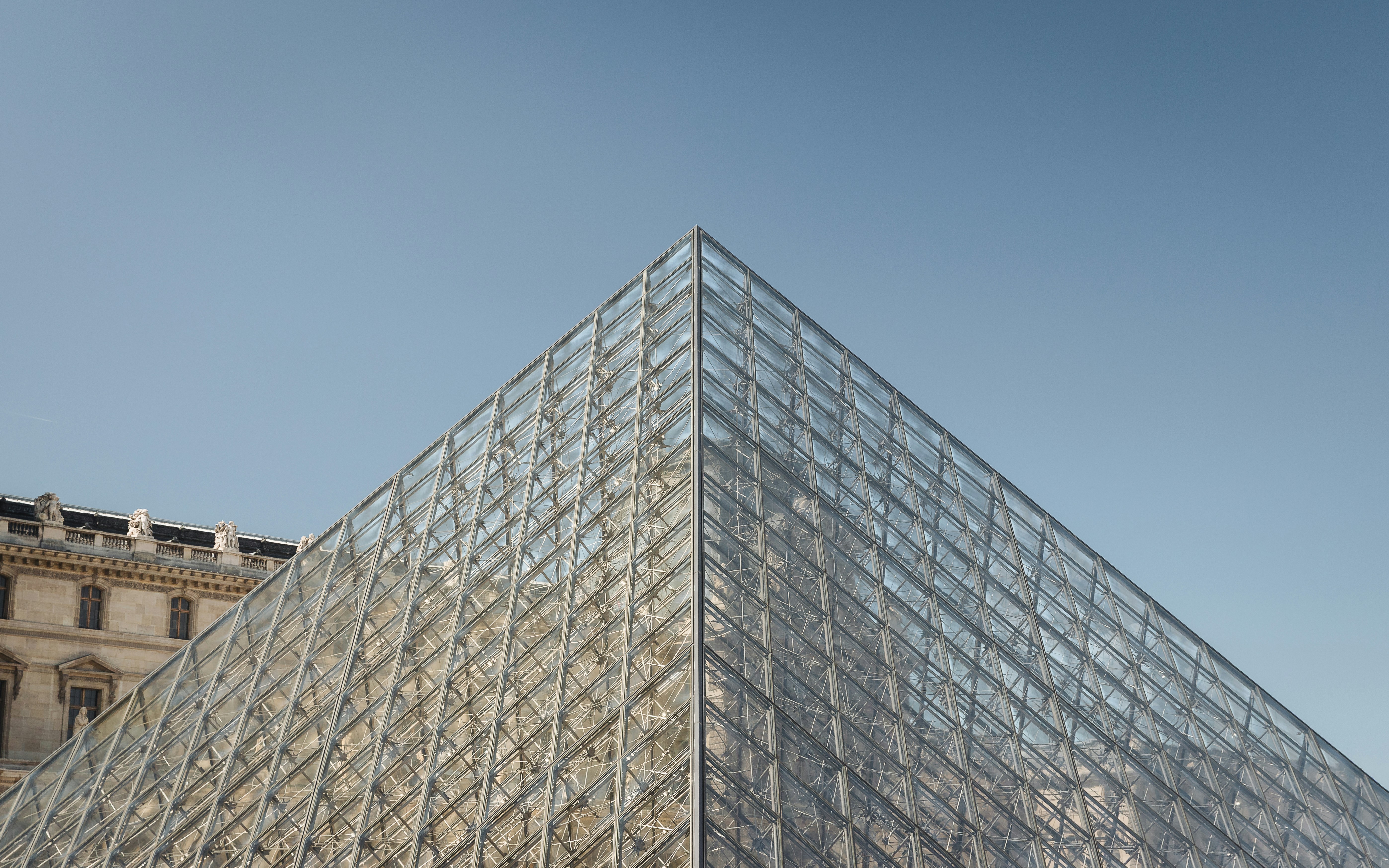 Glassed Peaks: The Louvre Pyramid Rising Above Classic Facades