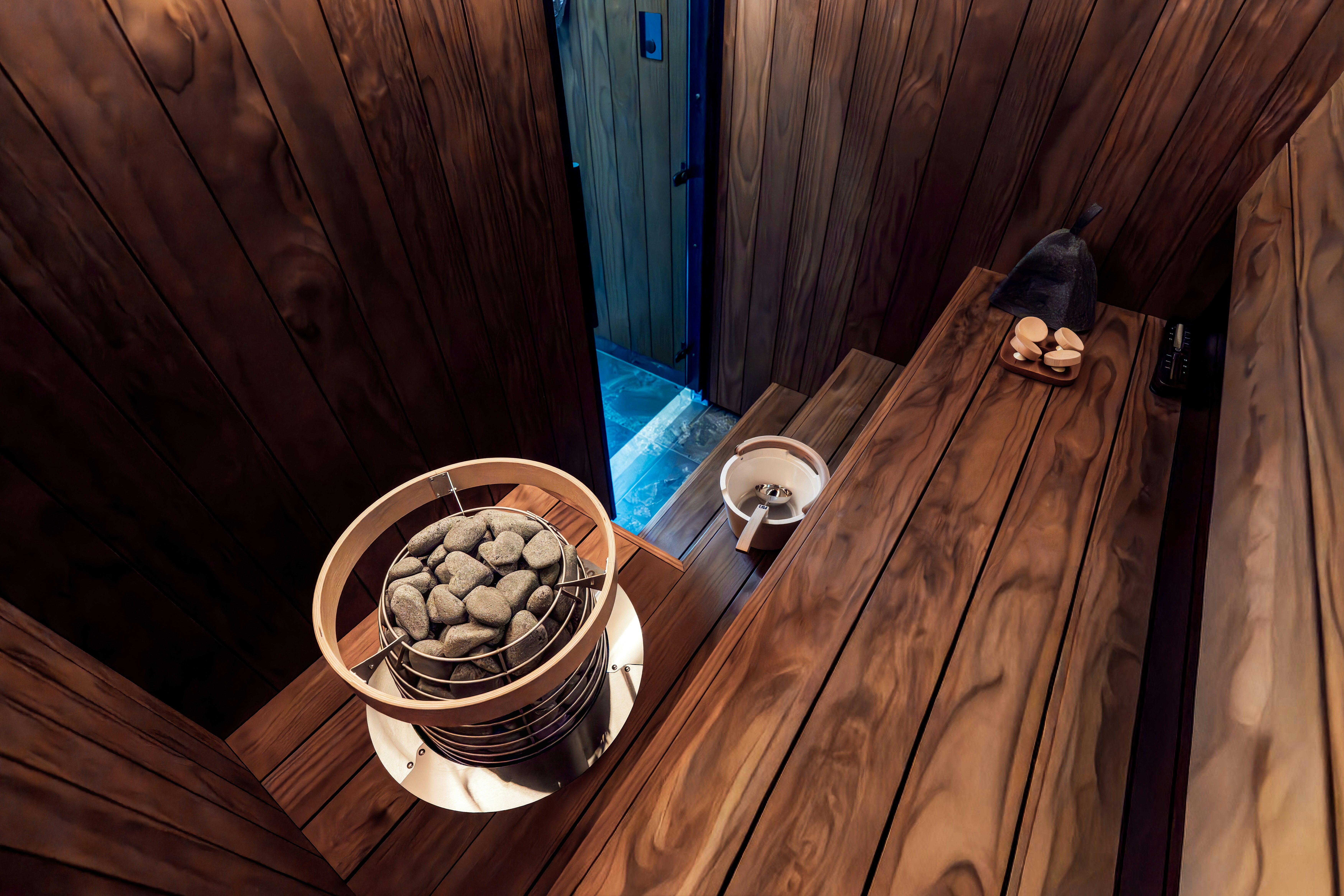 Pole of Warmth: Sauna Bench and Heater in Dim Wooden Studio