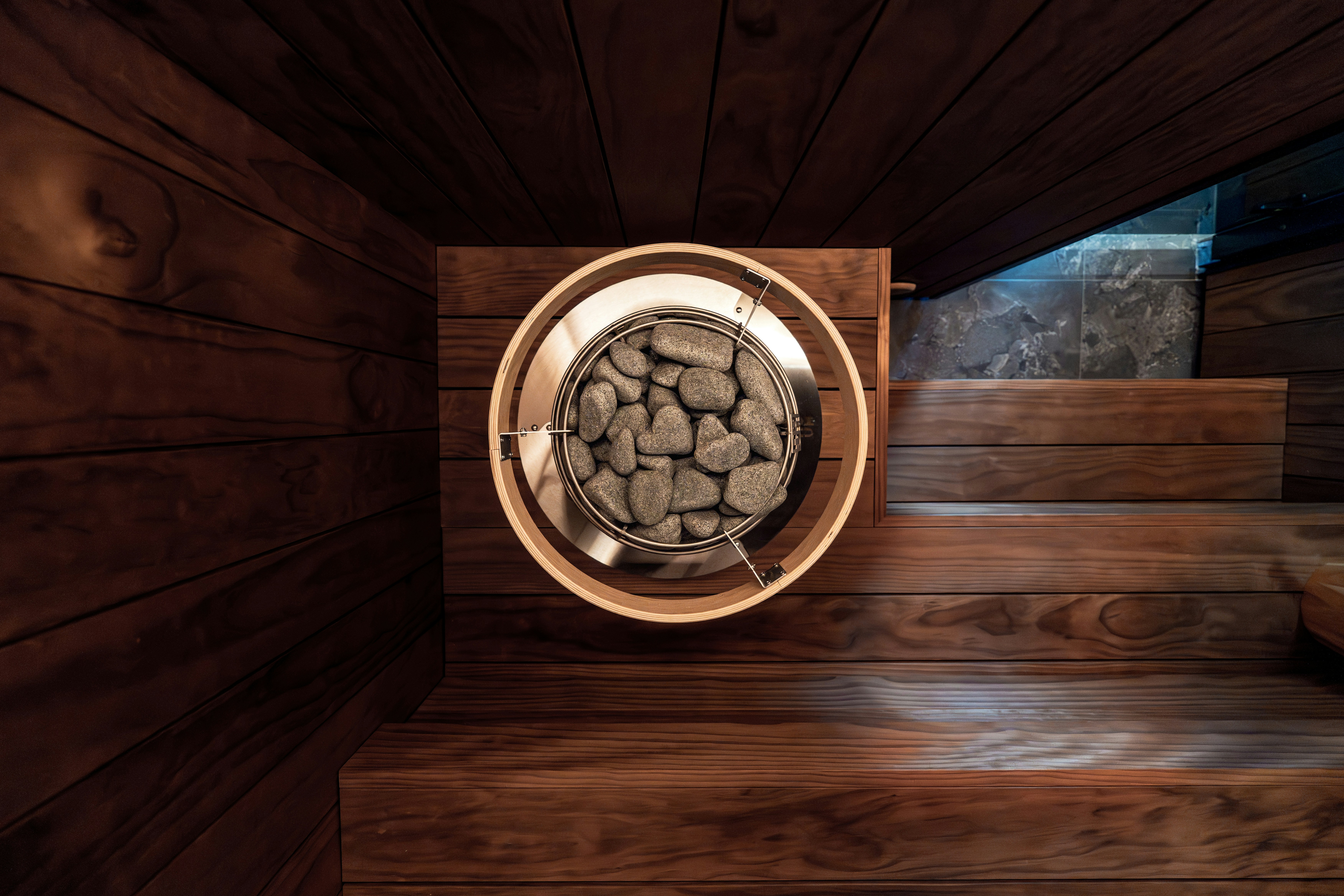 Circular Cozy: Sauna Stove Centered in Warm Wooden Steps