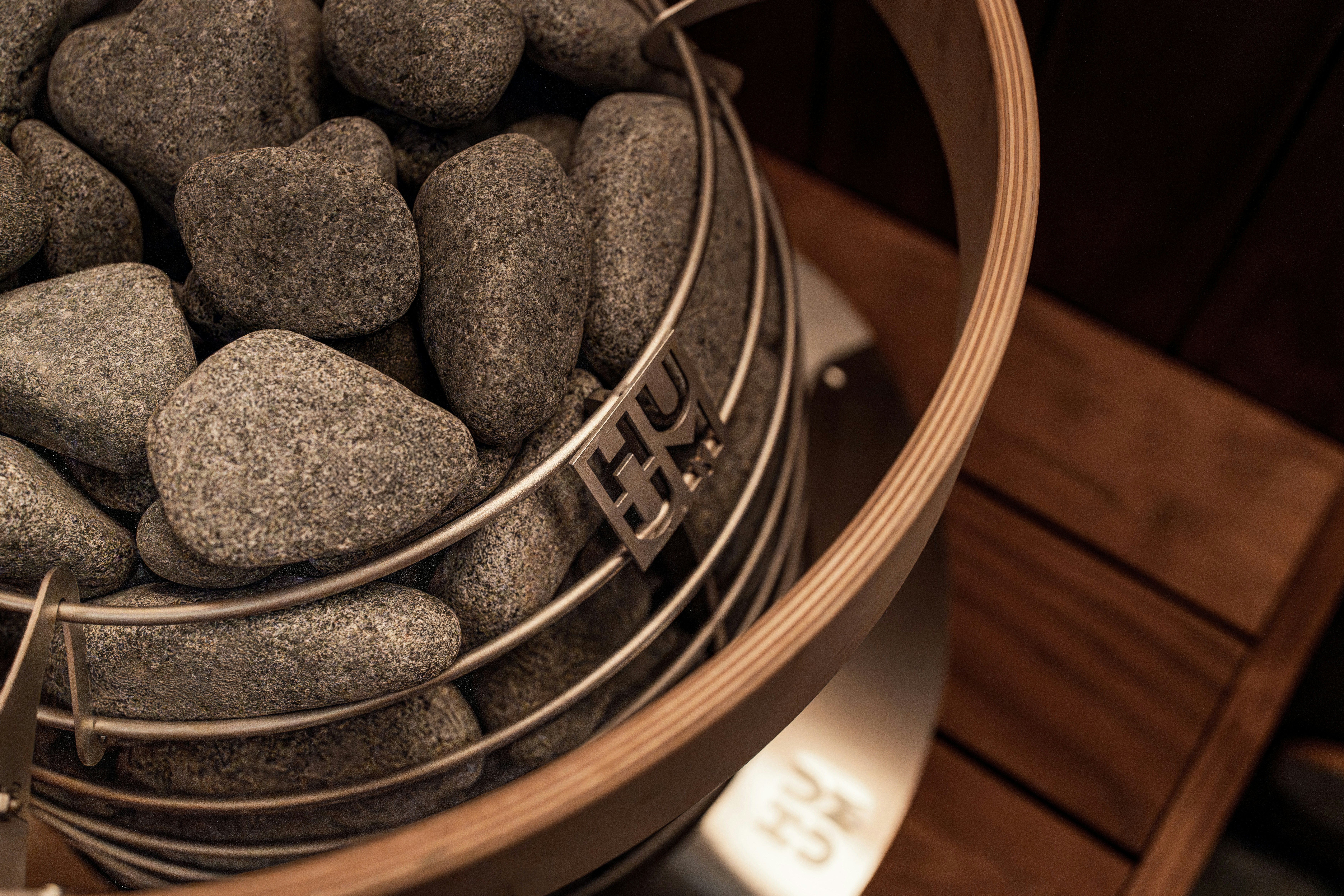 Hot Stones in a Copper Basket by Warm Wood Tones