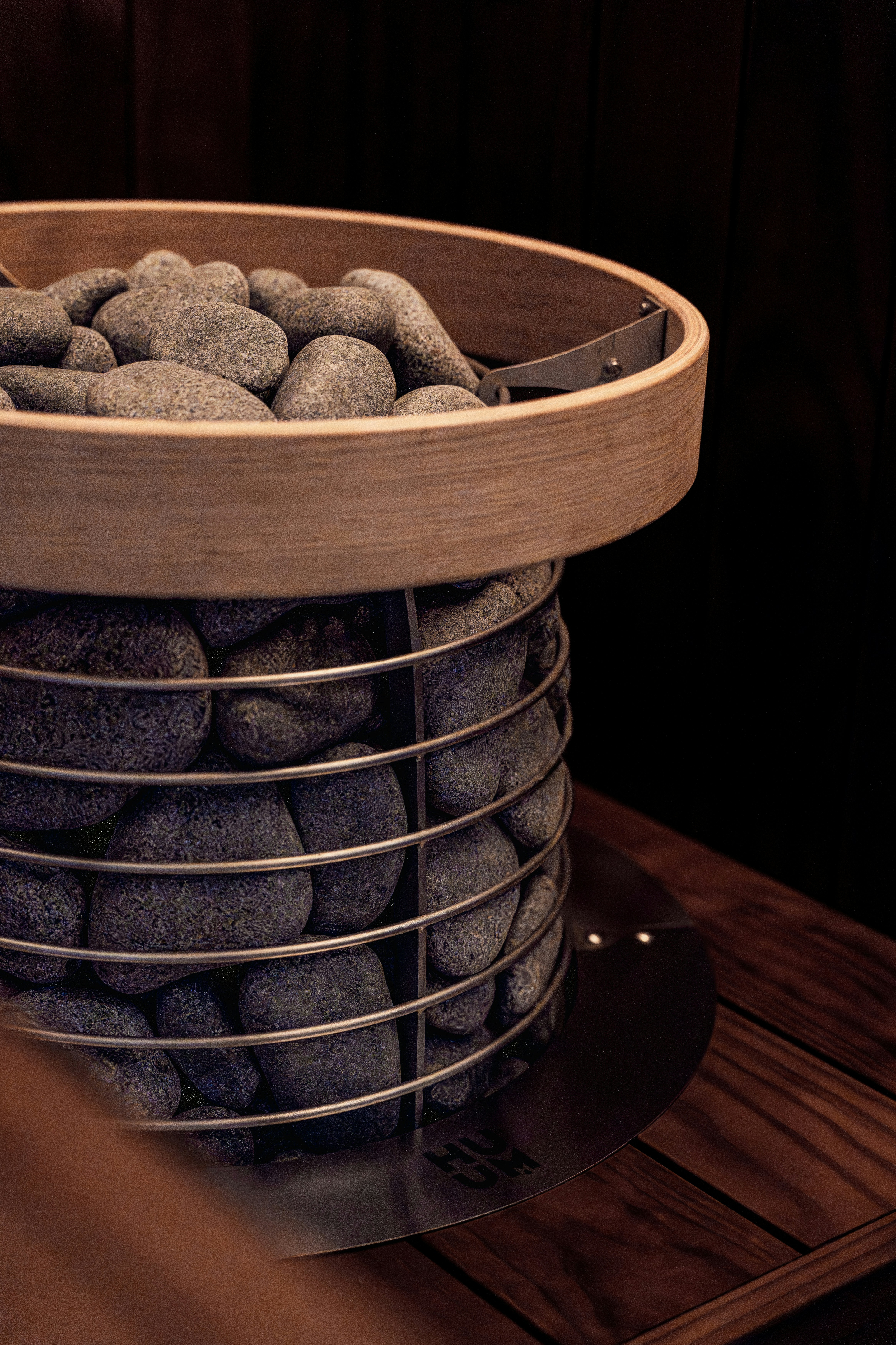 Wooden Basket of Smooth Stones in Warm Spa Lighting