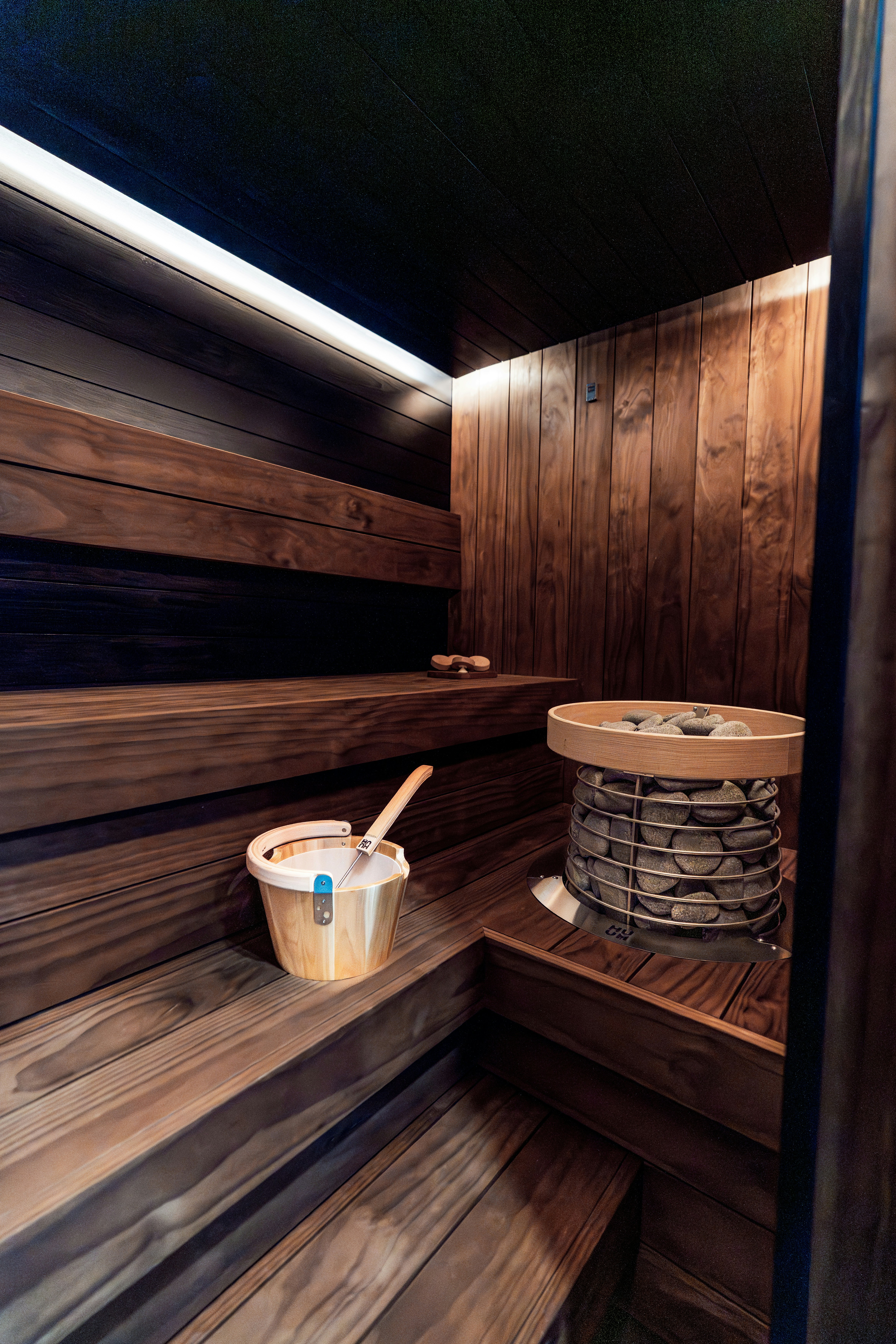 Wooden Sauna Tube: Stones, Water Bucket, and Ember Glow