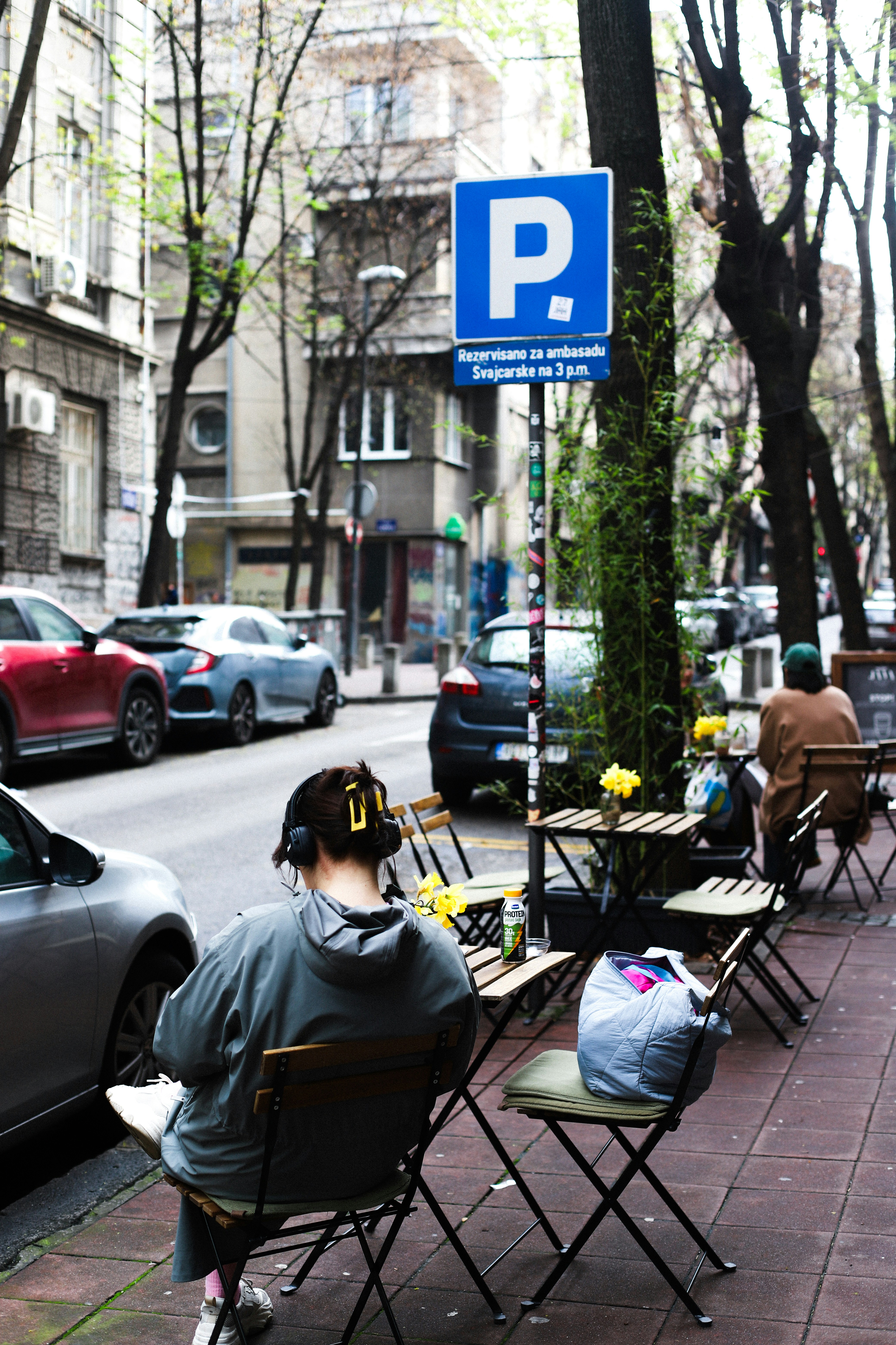 Urban Café Quiet: A Street Scene with a Listener at the Table