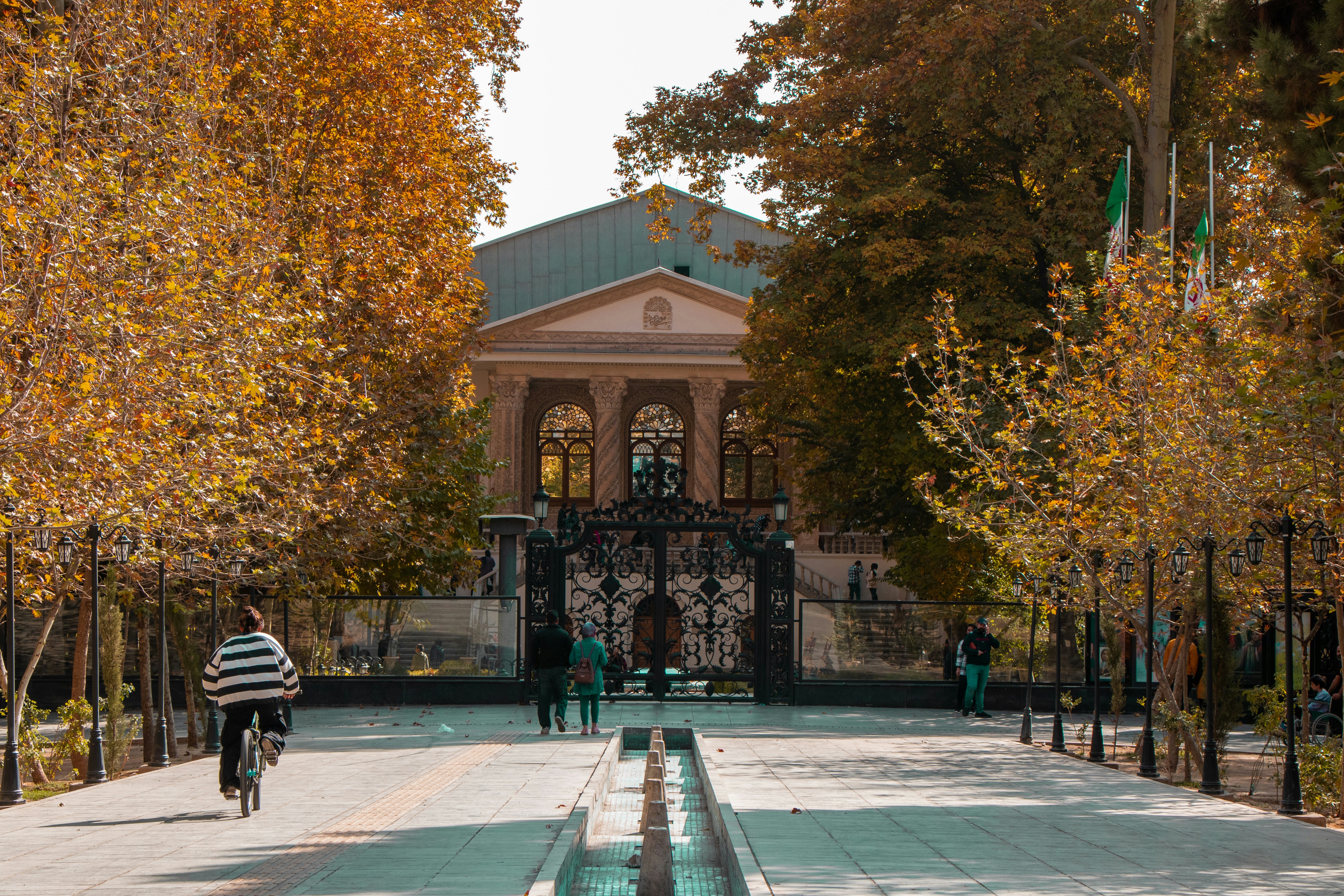 Autumn Approach to the Gate: A Quiet Campus Pathway