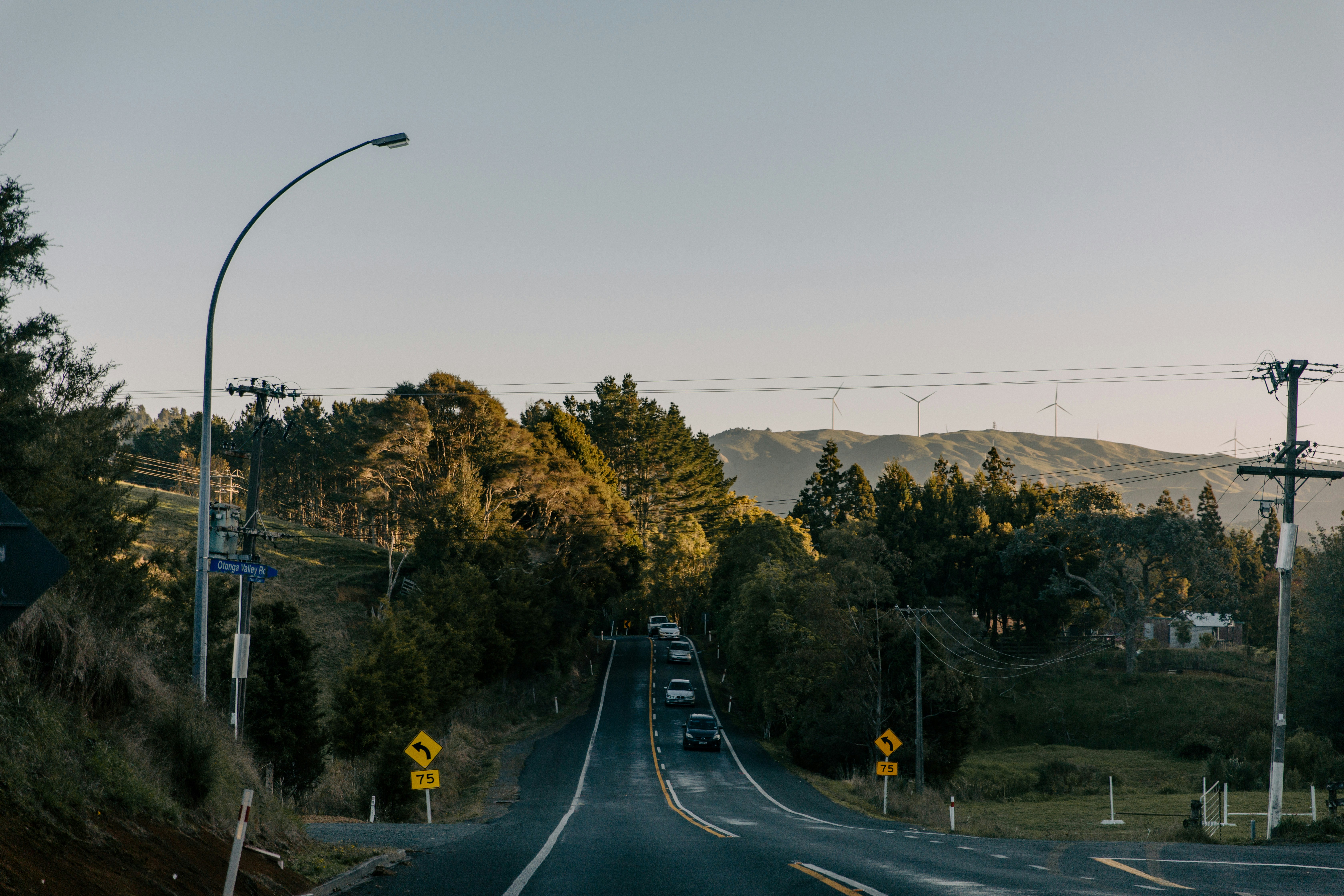 Golden Hour Ascent: A Quiet Highway Toward Distant Hills