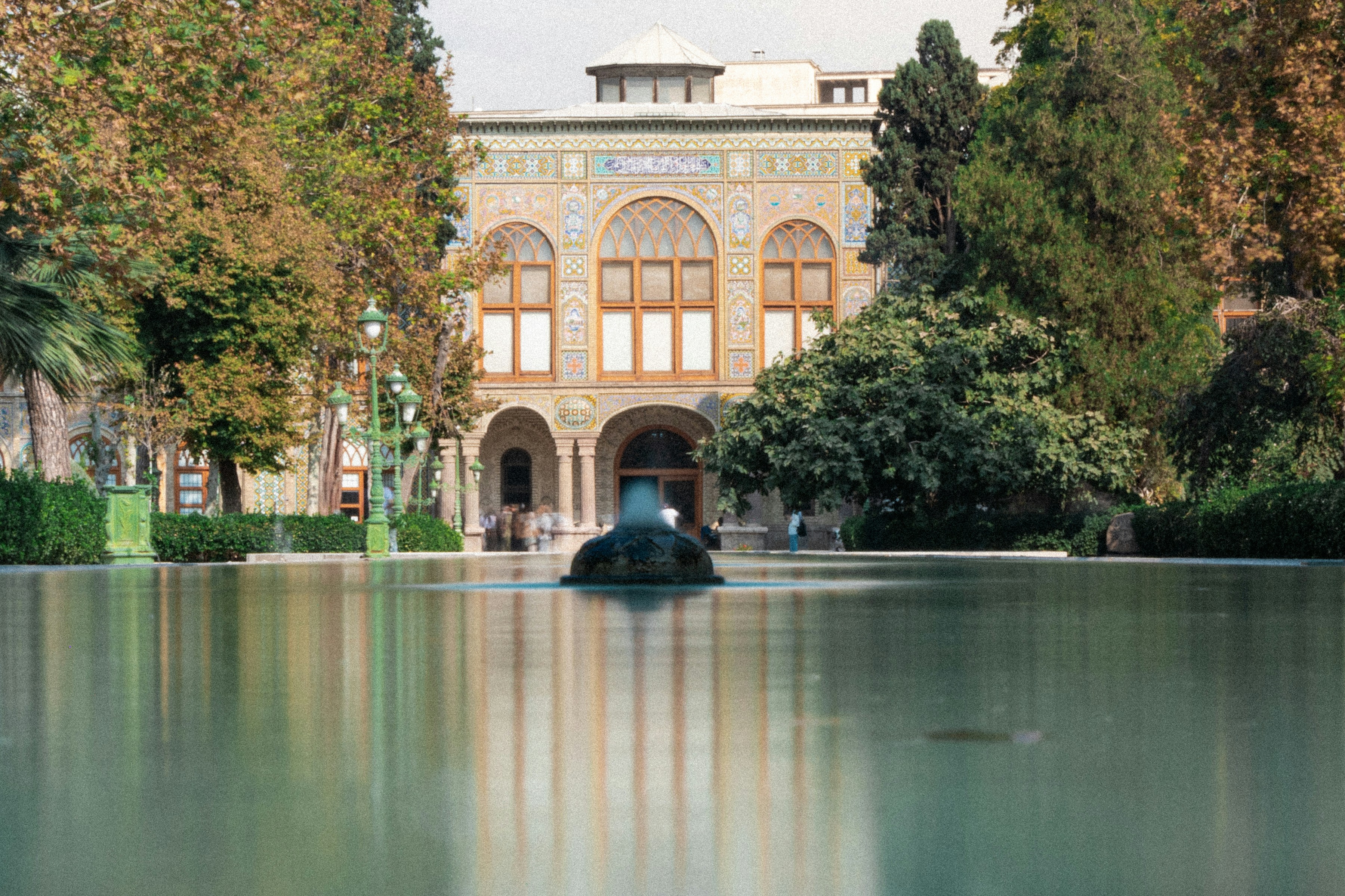 Reflection in the Courtyard Fountain: A Marble Facade Framed by Autumn Trees