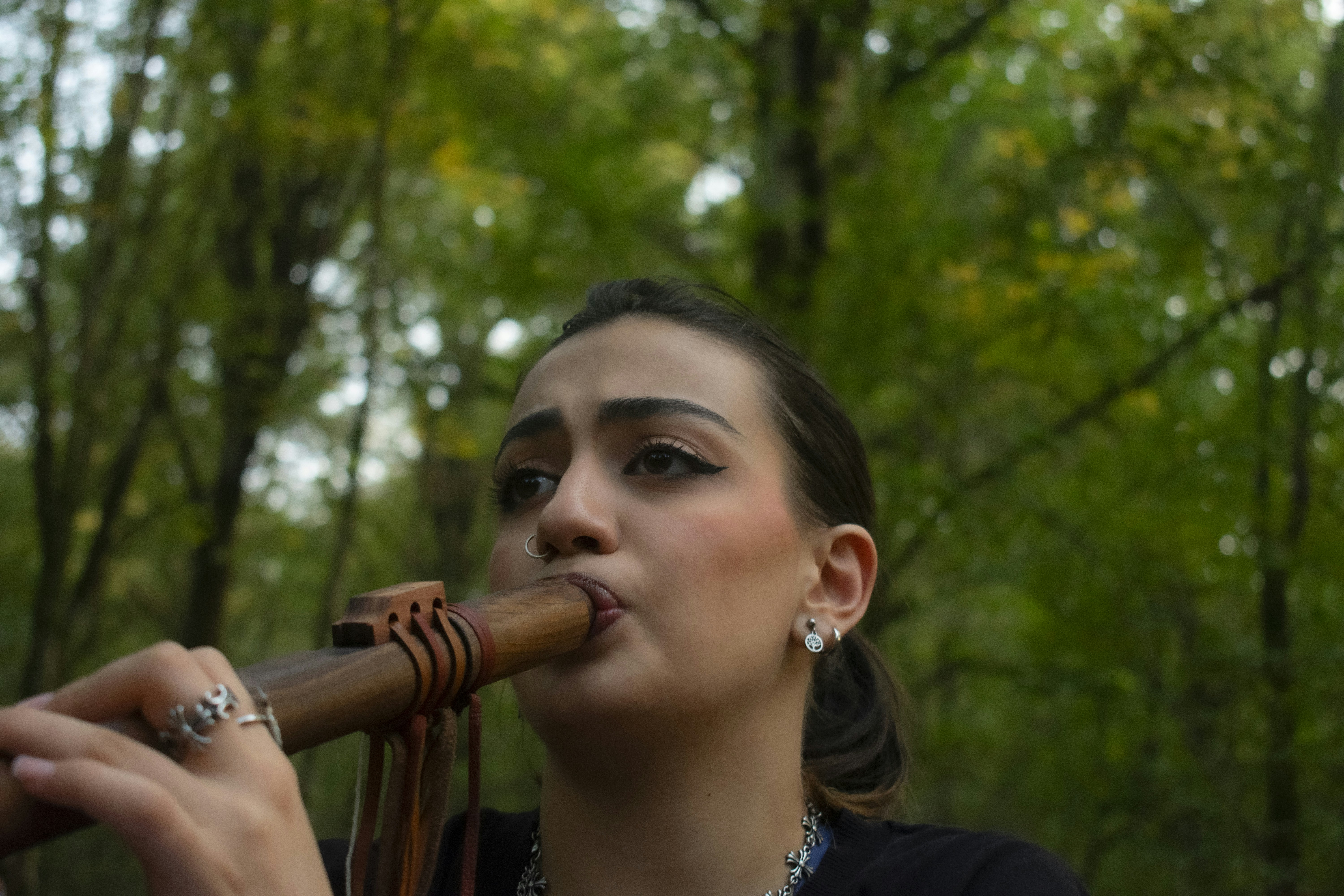 Woodland Melodies: Close-Up of a Flutist in the Green Corridor