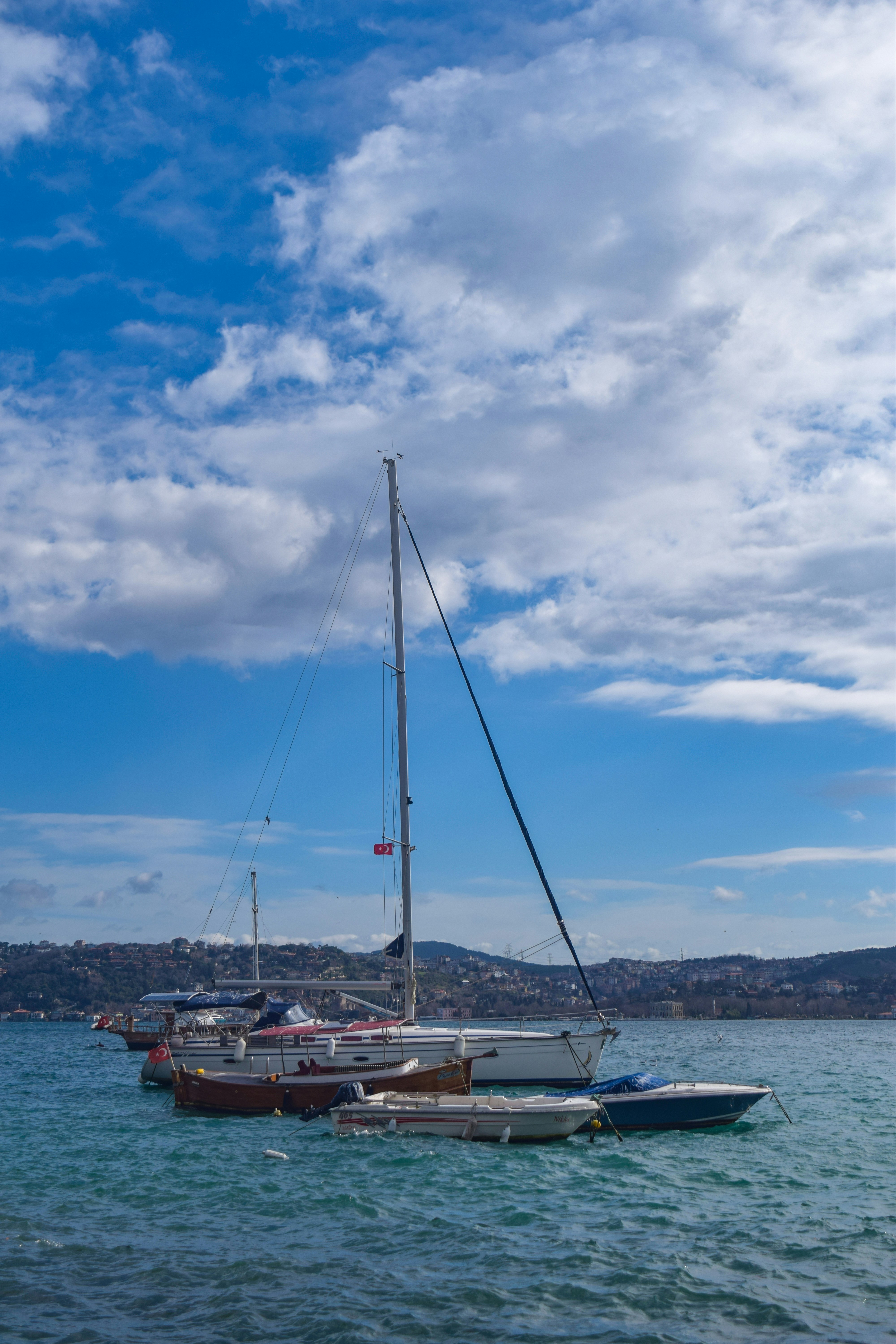 Sailing Silence: Boats Rest on a Calm Bay beneath a Blue Sky