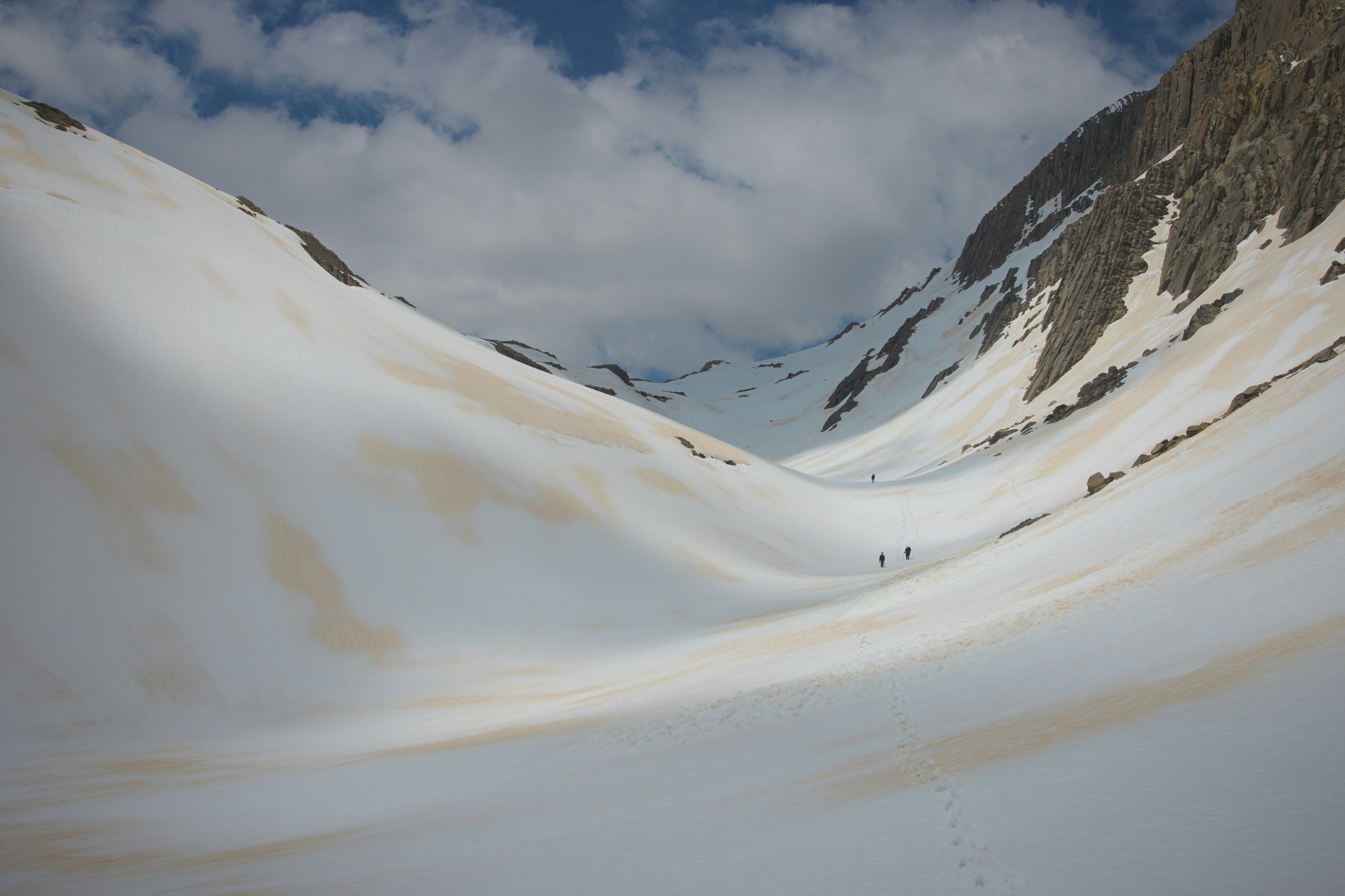 Silent Ascent: Two Silhouettes Between Snowbound Ridges