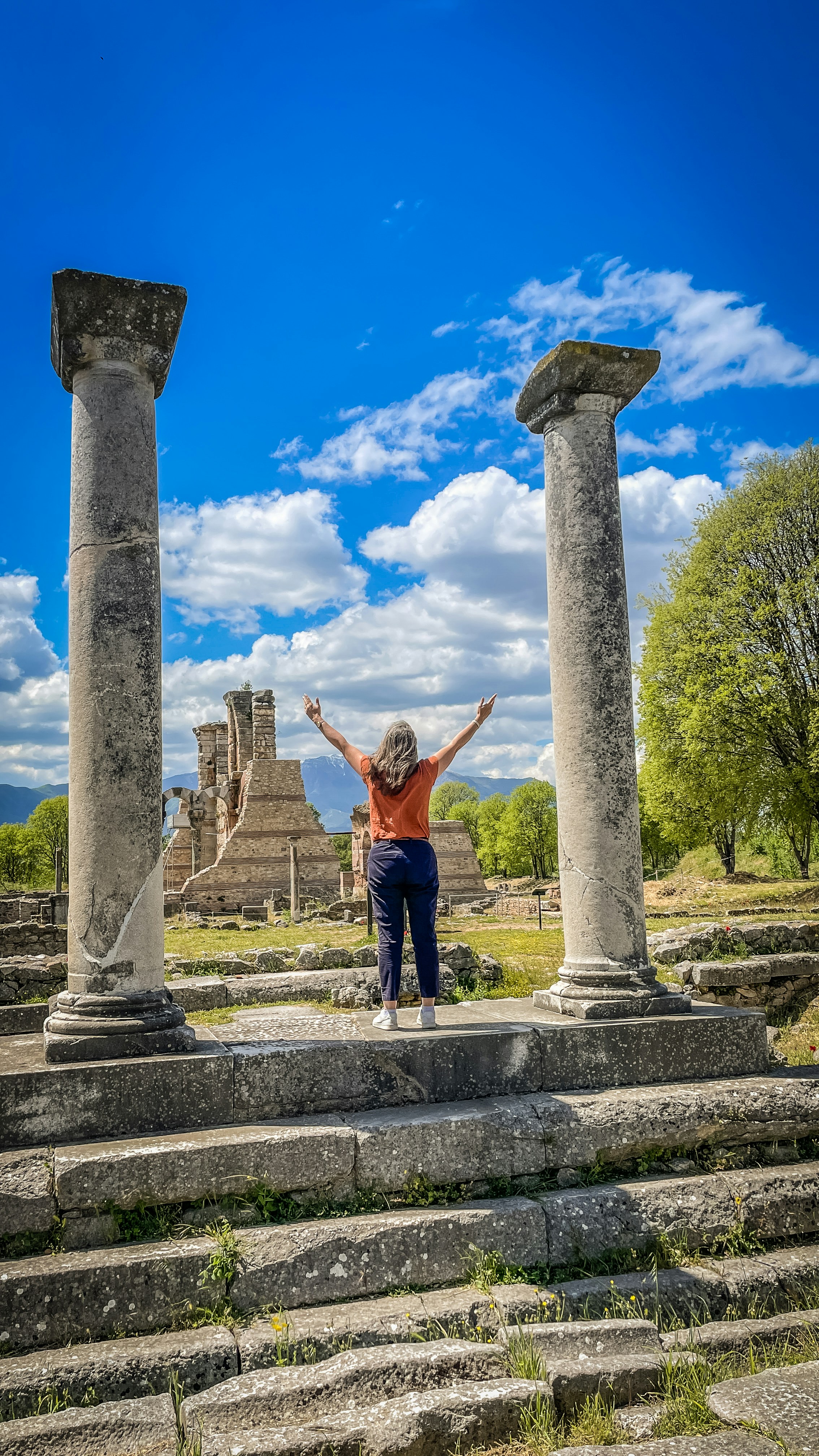 Rings of Time: A Traveler Stands Among Ancient Columns