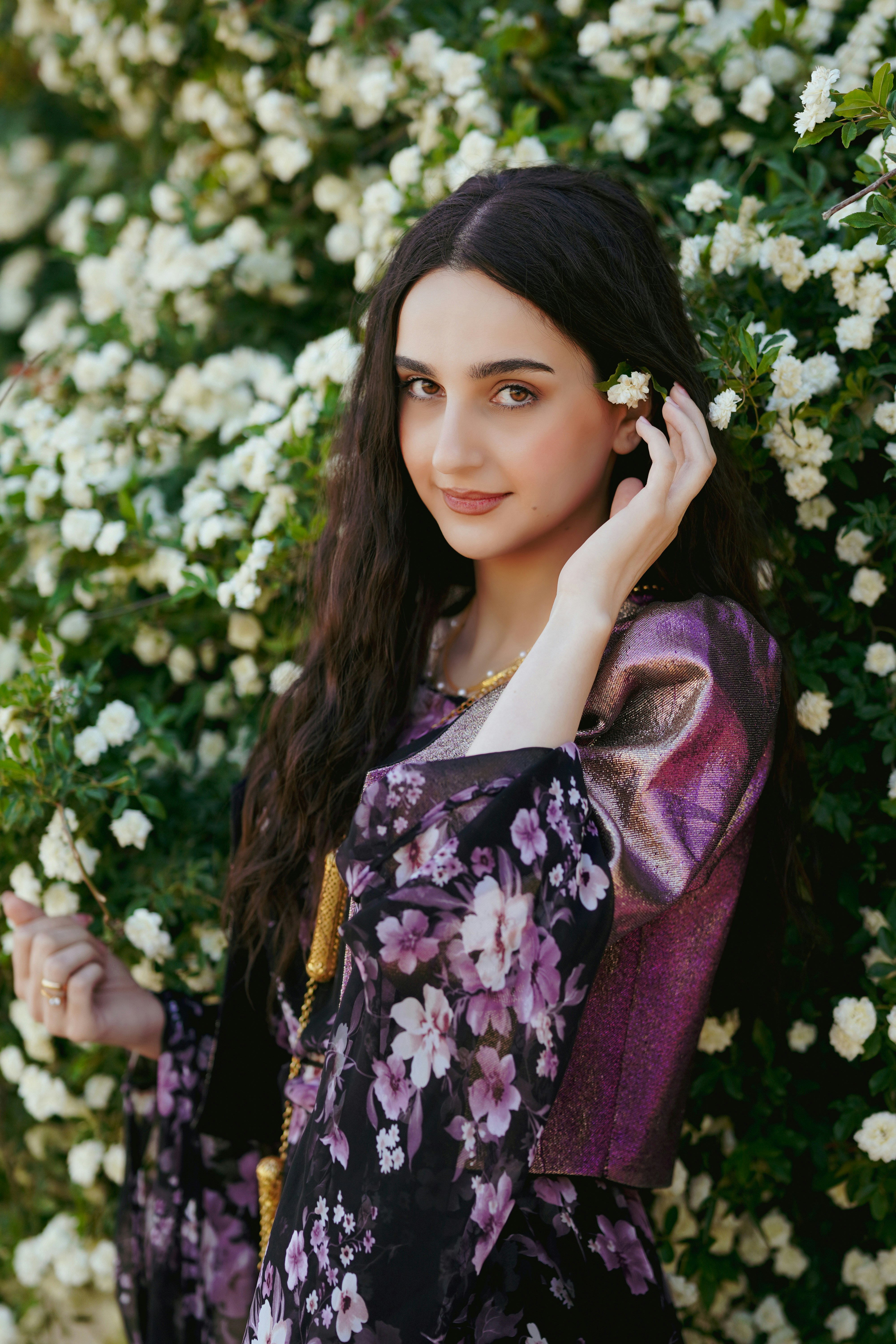  Bloomed vignette: Portrait of a woman among white blossoms in a floral backdrop