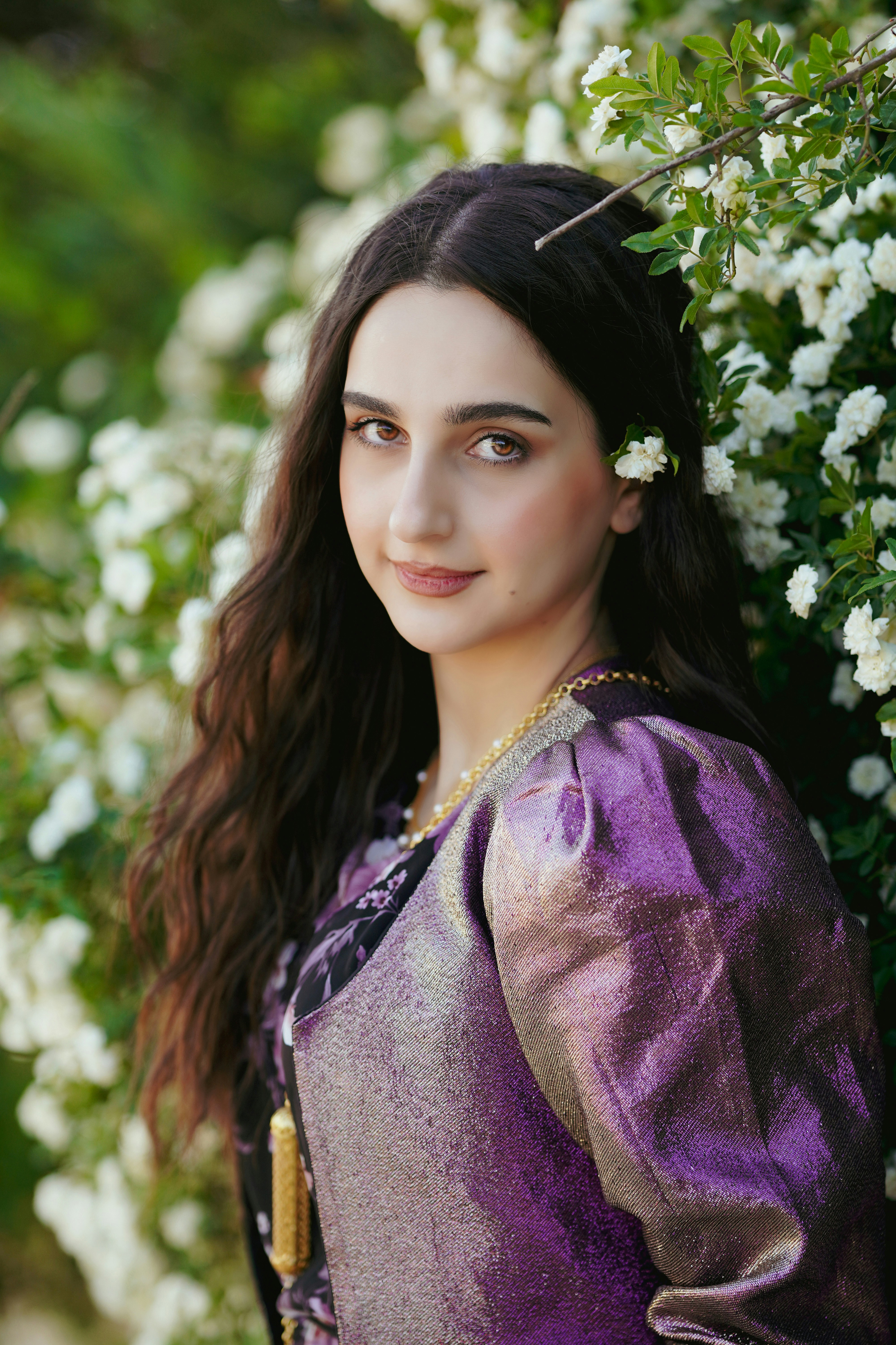 Lavender-gold portrait beneath blooming white canopies