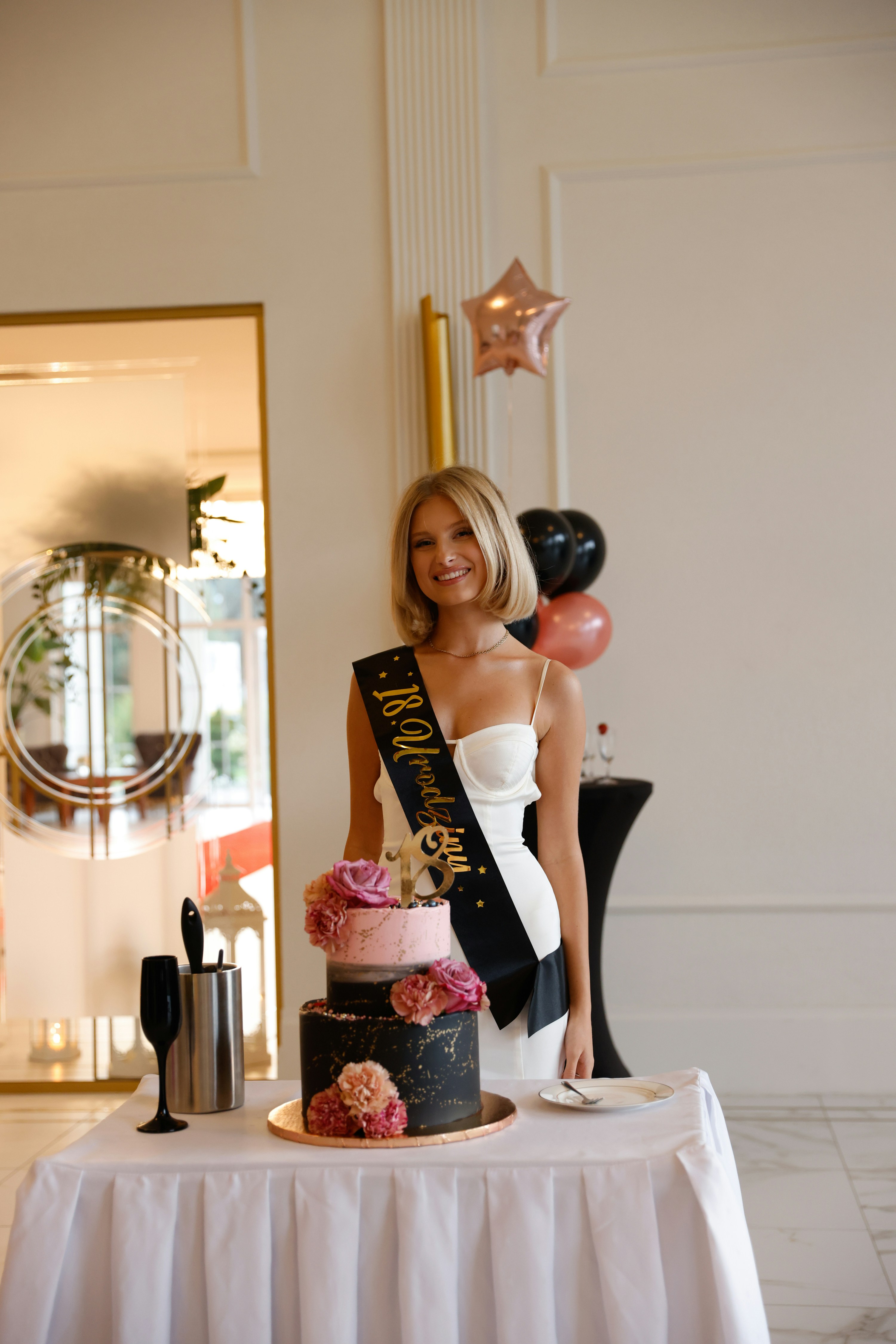 Celebration Glow: A Birthday Moment with Floral Cake and Sash
