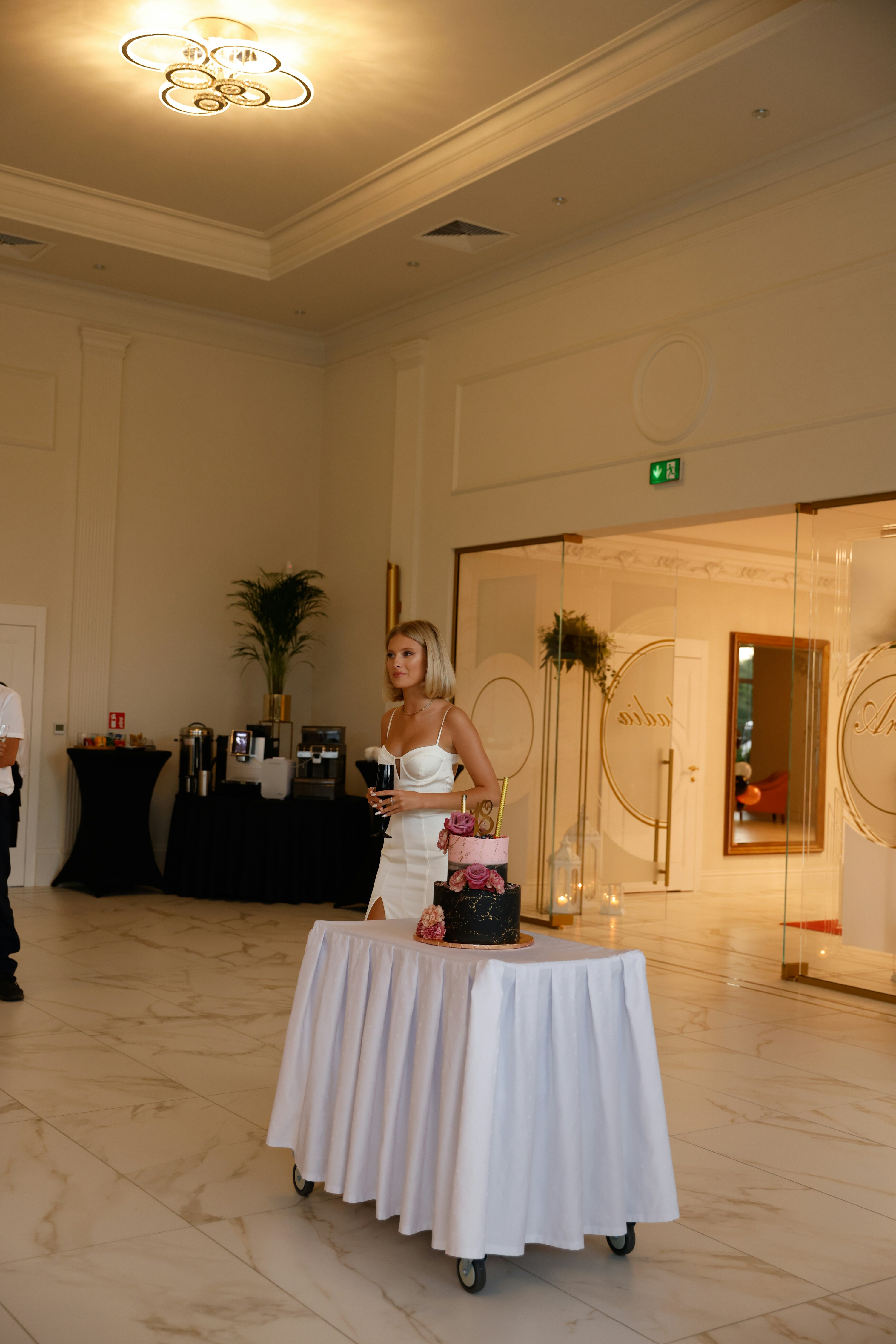 Elegance in White: A Cake and Glasses Moment in the Lobby