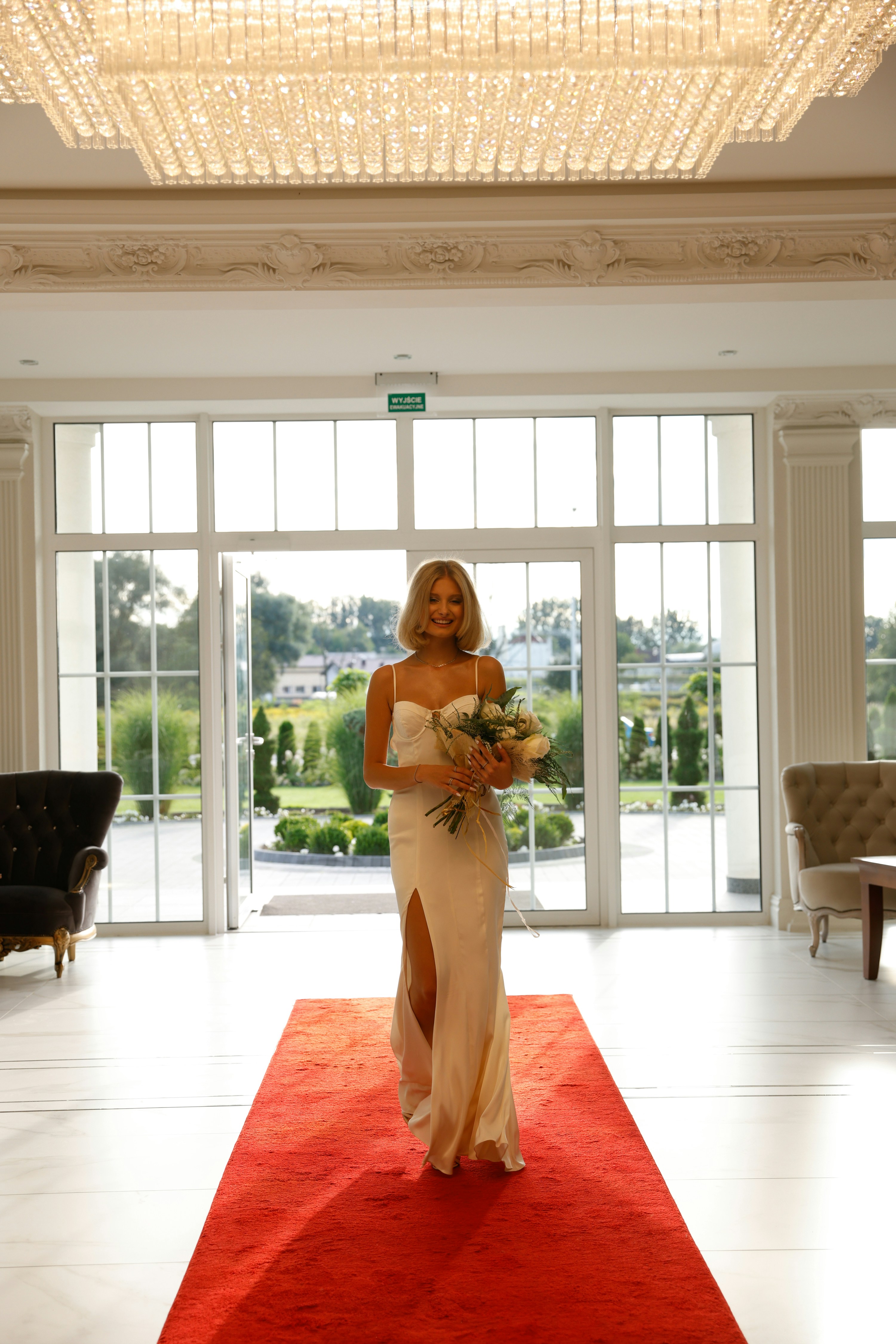 Bride in a Velvet Hall: a bridal stroll on a crimson carpet