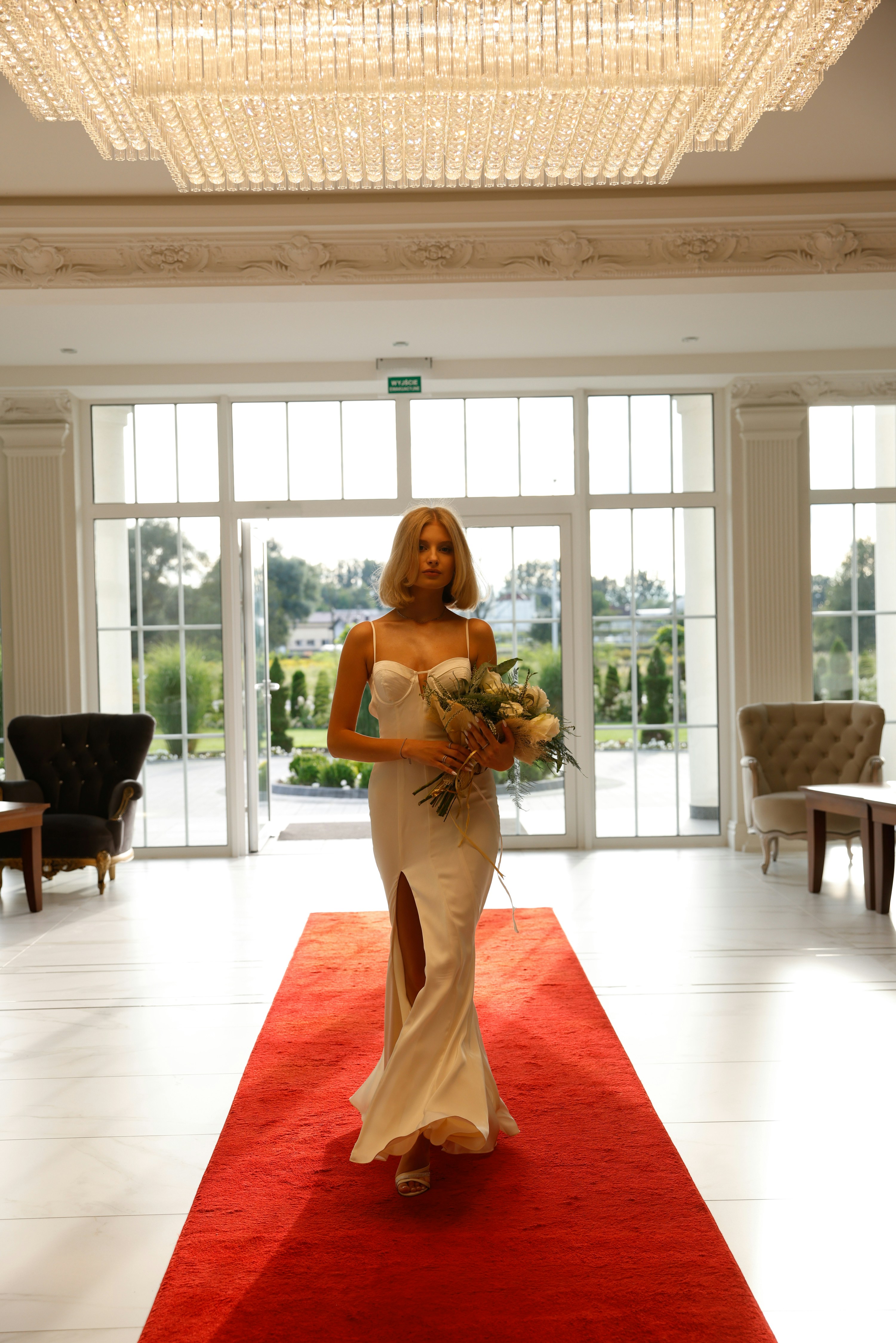 Bride on the Red Carpet: Elegance in a Sunlit Foyer
