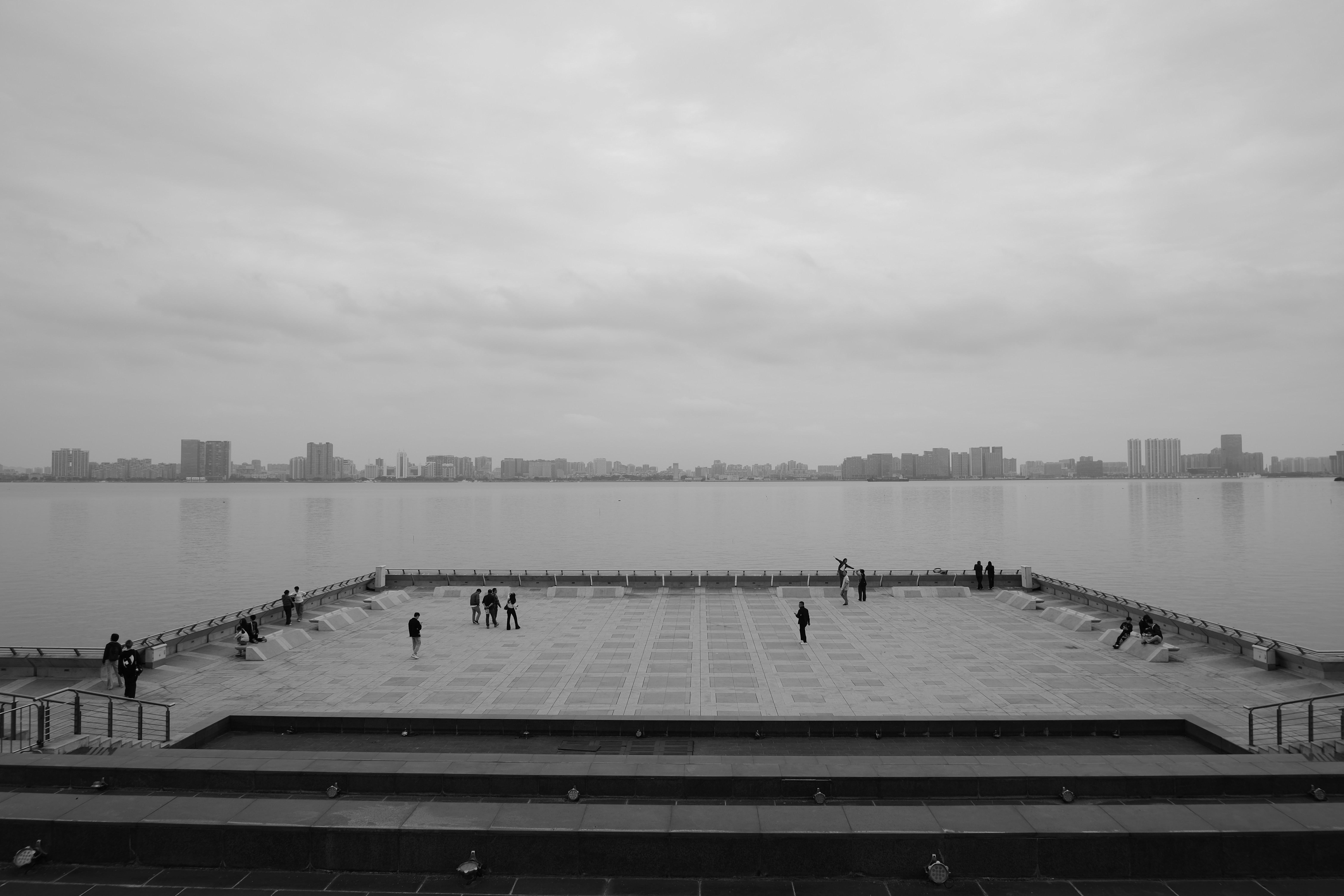 Muted Horizon, Quiet Promenade: People at the Pier