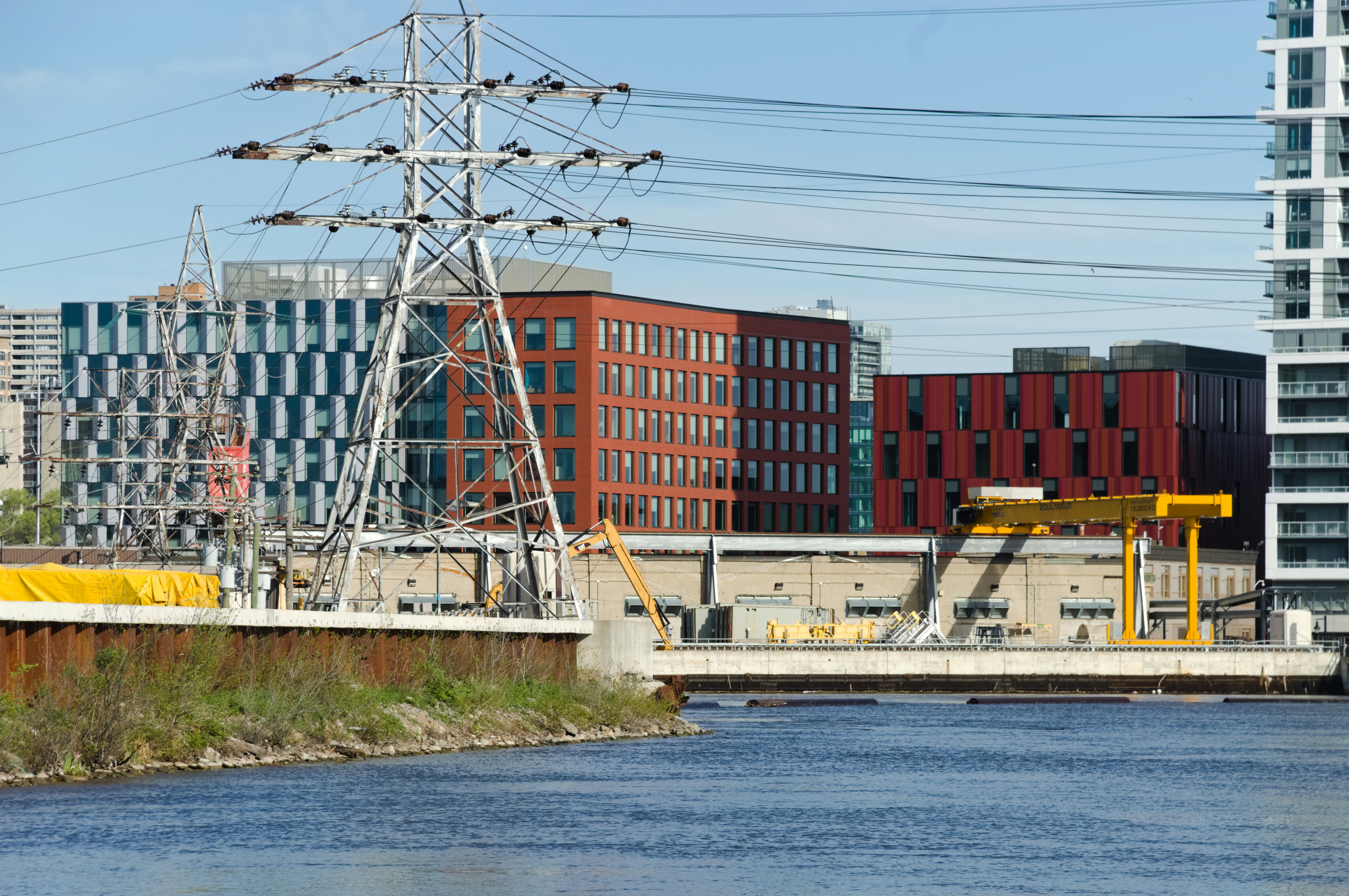 Industrial Waterfront with Modern Buildings and Power Line Crisscross
