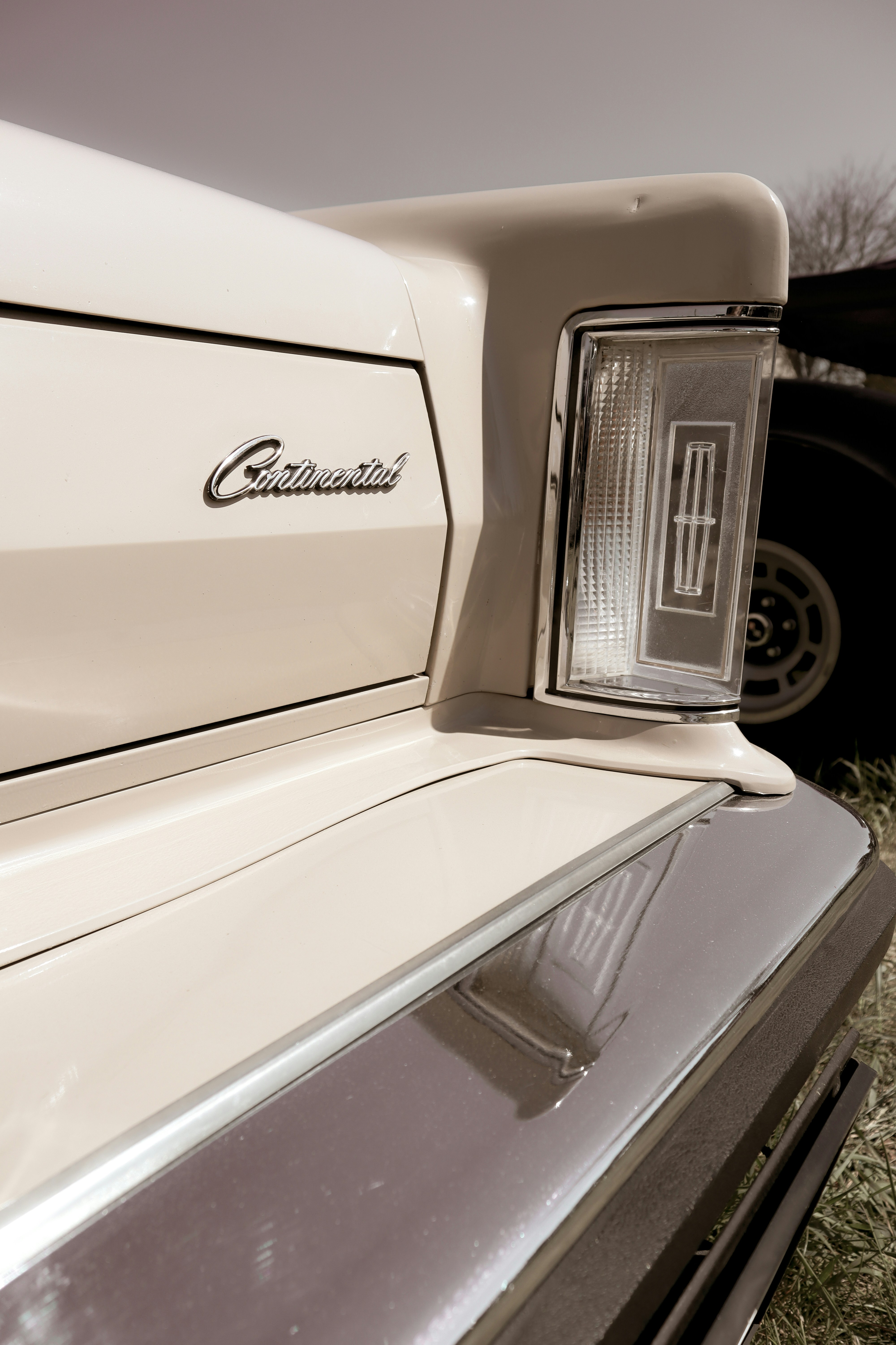 Tailfin and badge: a vintage Continental ride in soft sepia light