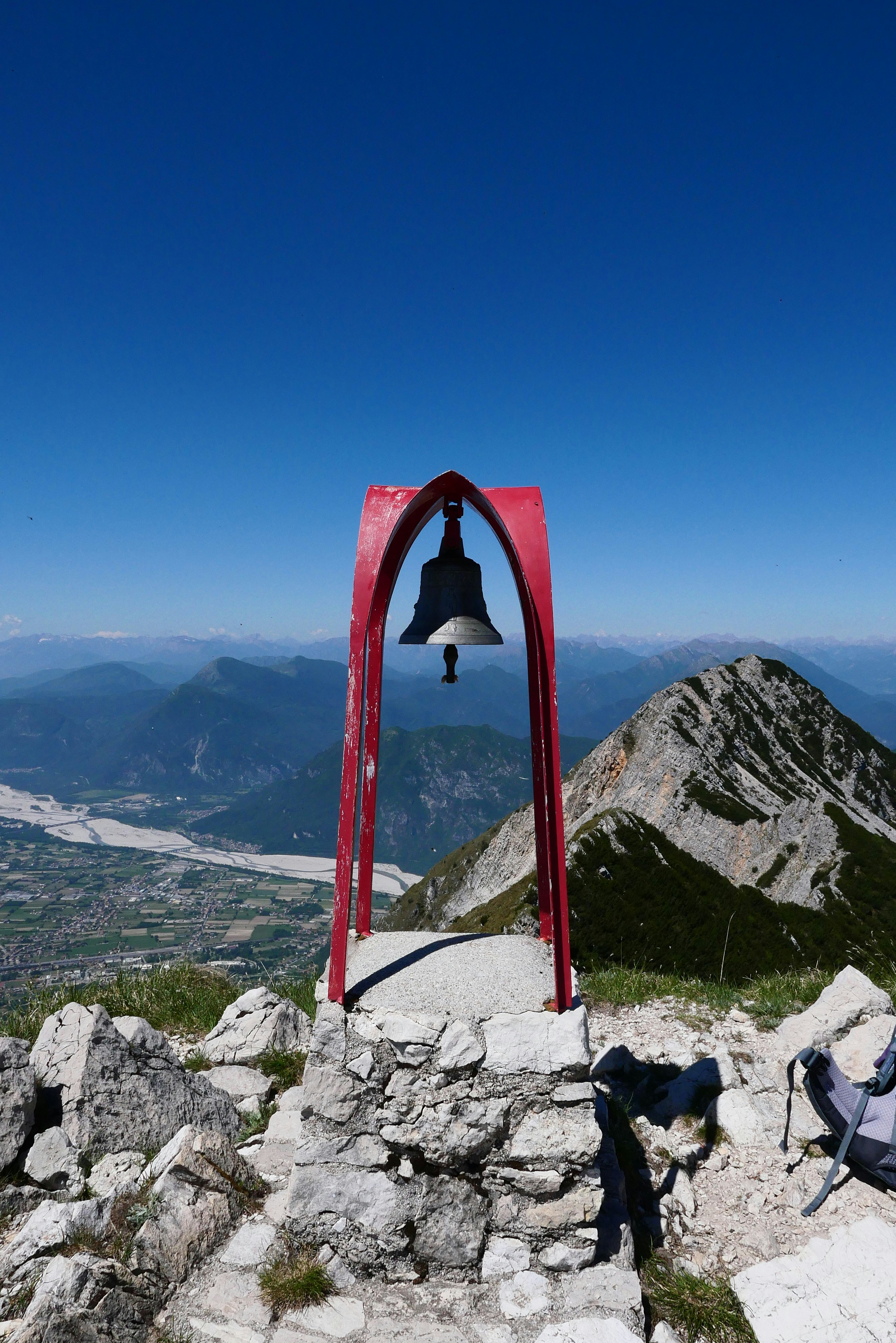 Bell Arch atop the Alps: A Weathered Red Frame with Summit Bell