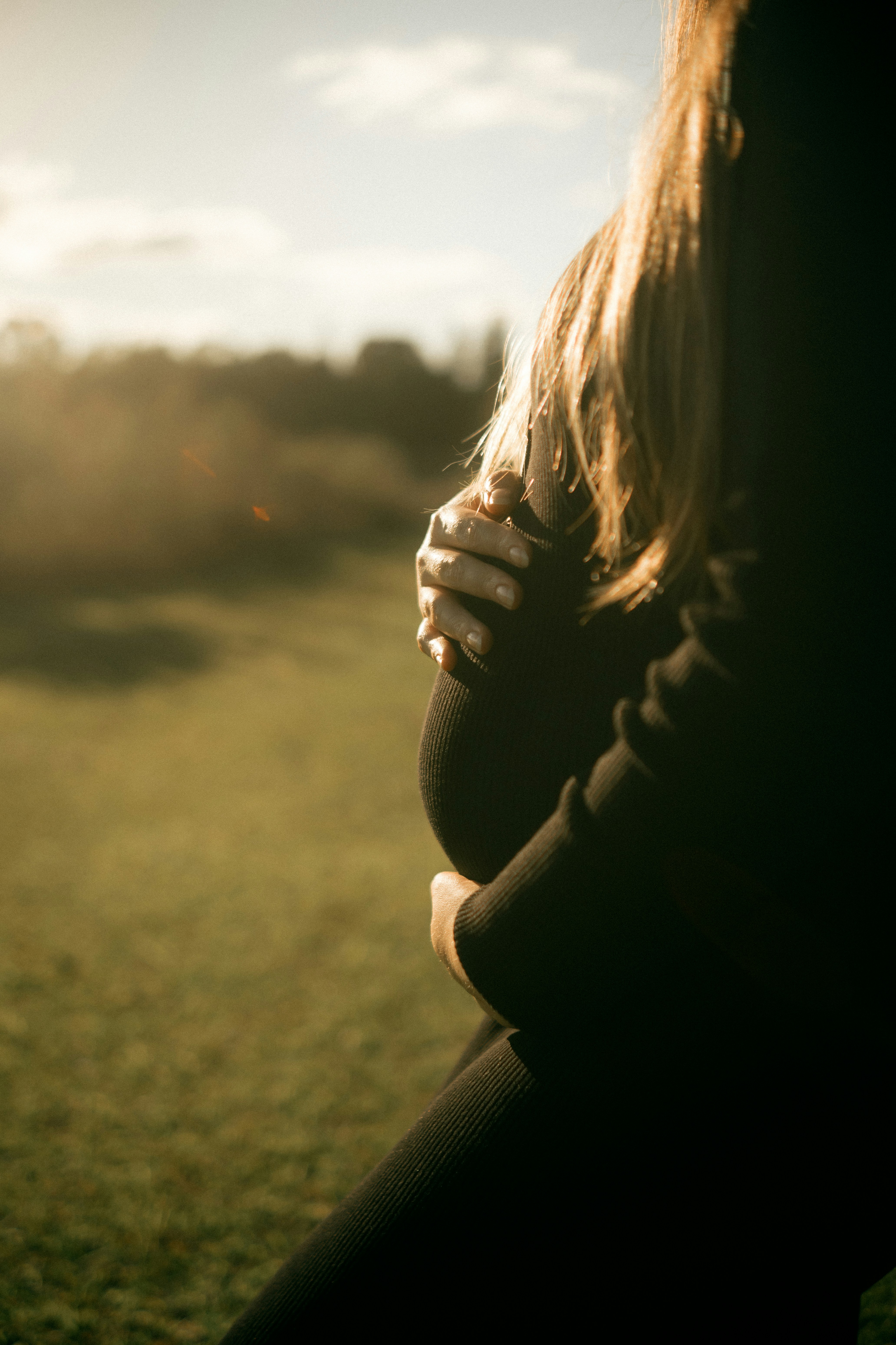 Golden Hour Embrace: A Quiet Portrait of Expectation