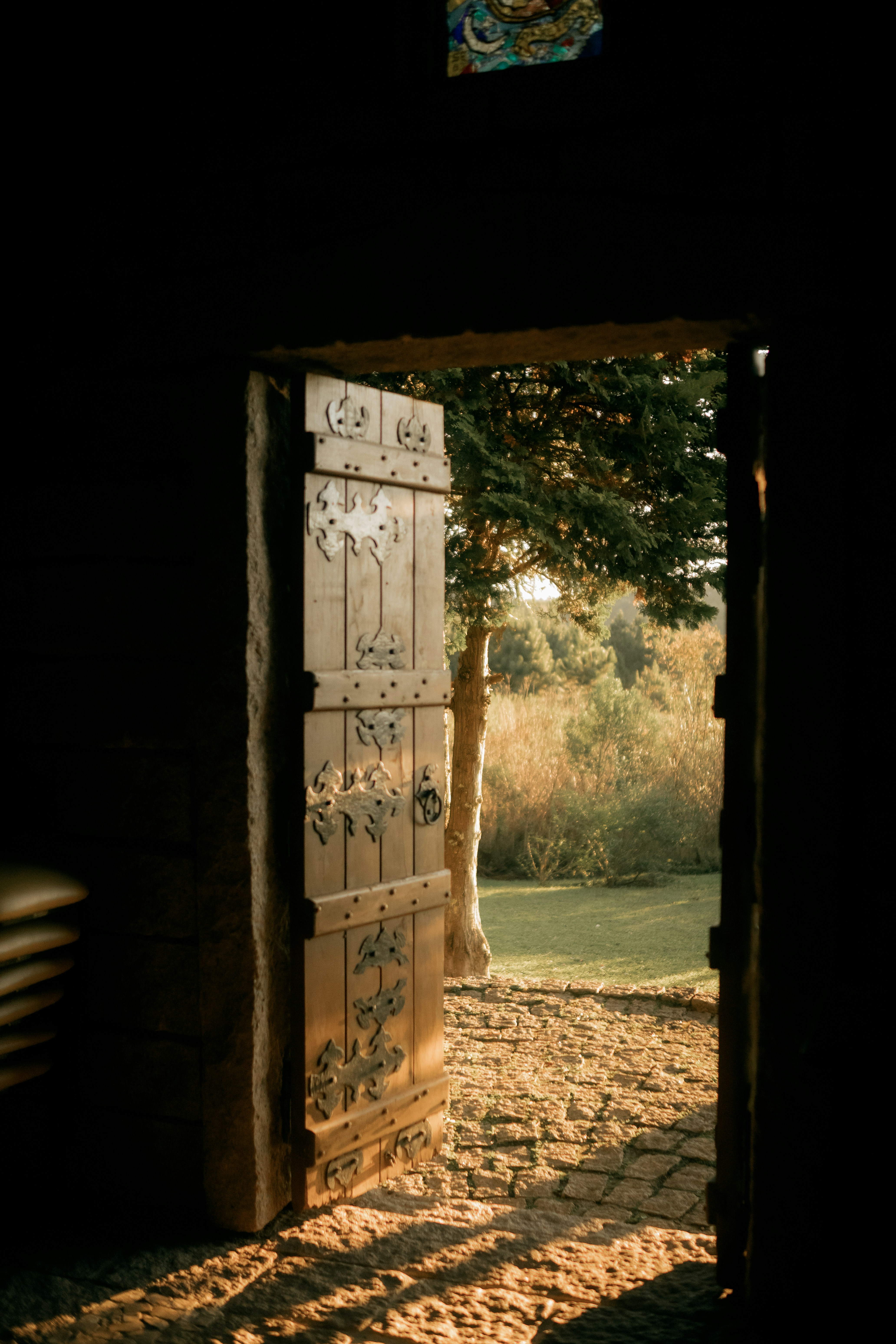 Gateway to Golden Light: Sunlit Doorway in a Quiet Courtyard