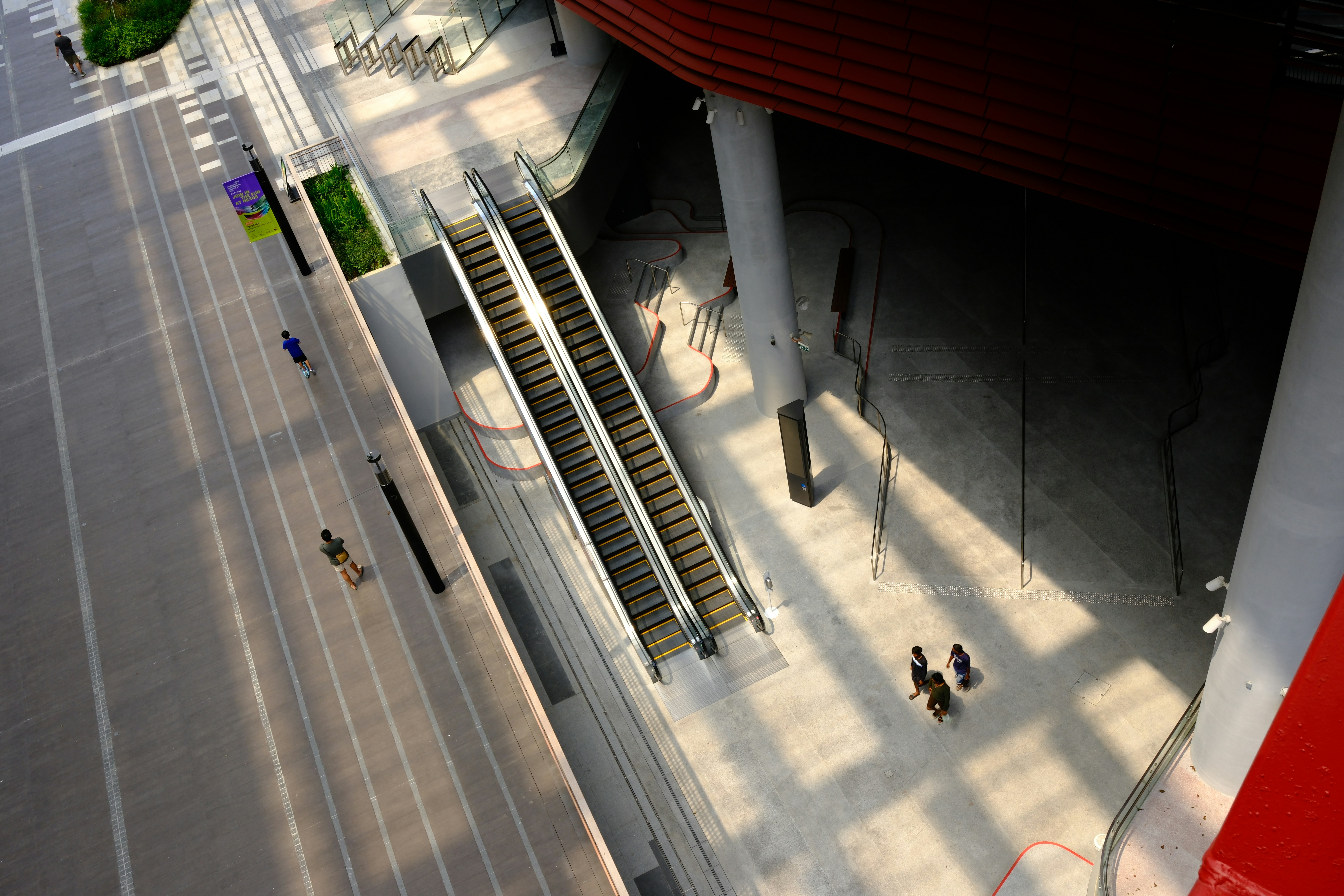 Shadows and Escalators: A Quiet Moment in an Urban Atrium