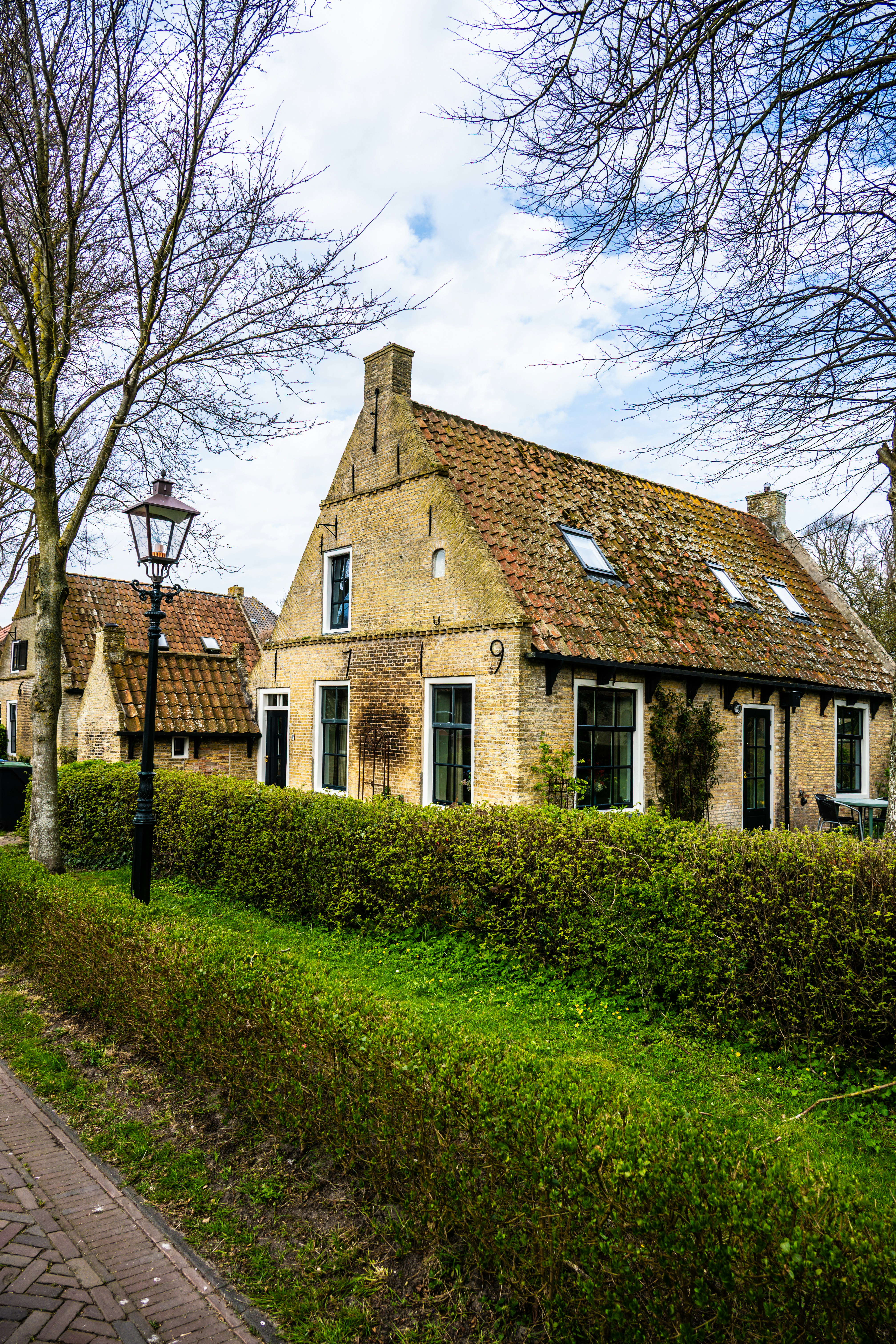 Quaint Dutch-style House Beside a Hedge-lined Lane