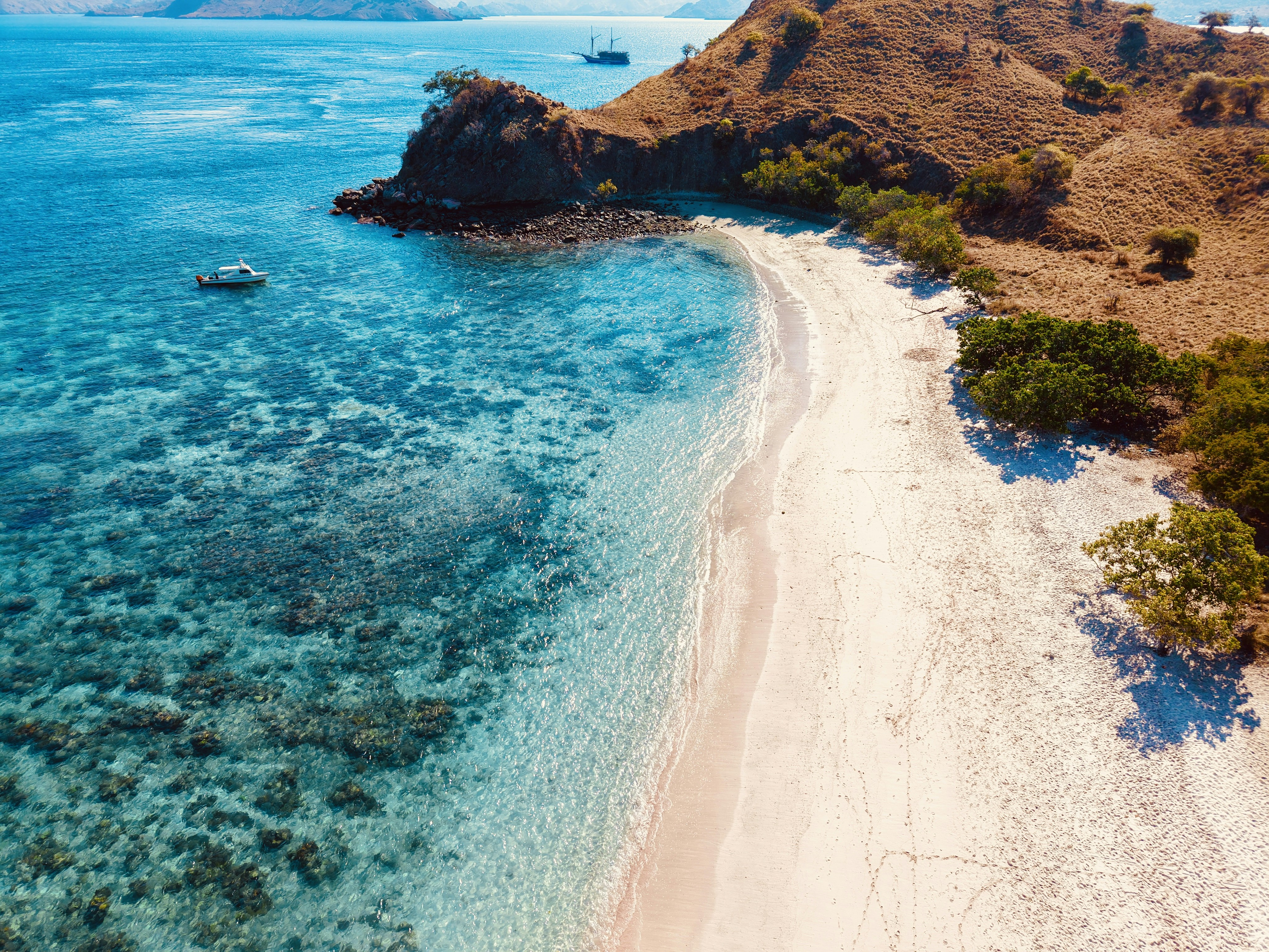 Azure Strand: Aerial Landing at the Curved Beach