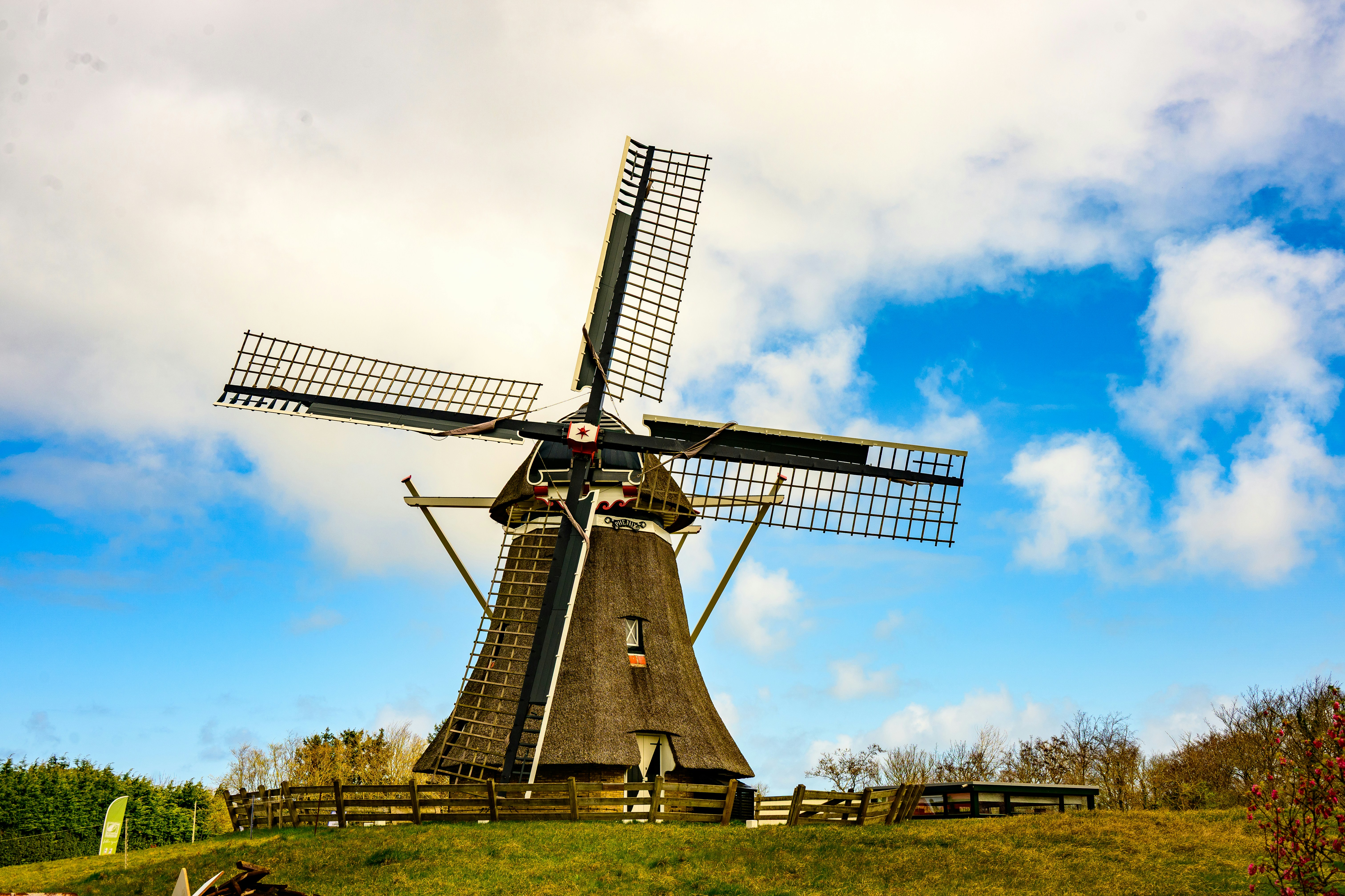 Windmill on a Gentle Hill under a Bright Sky