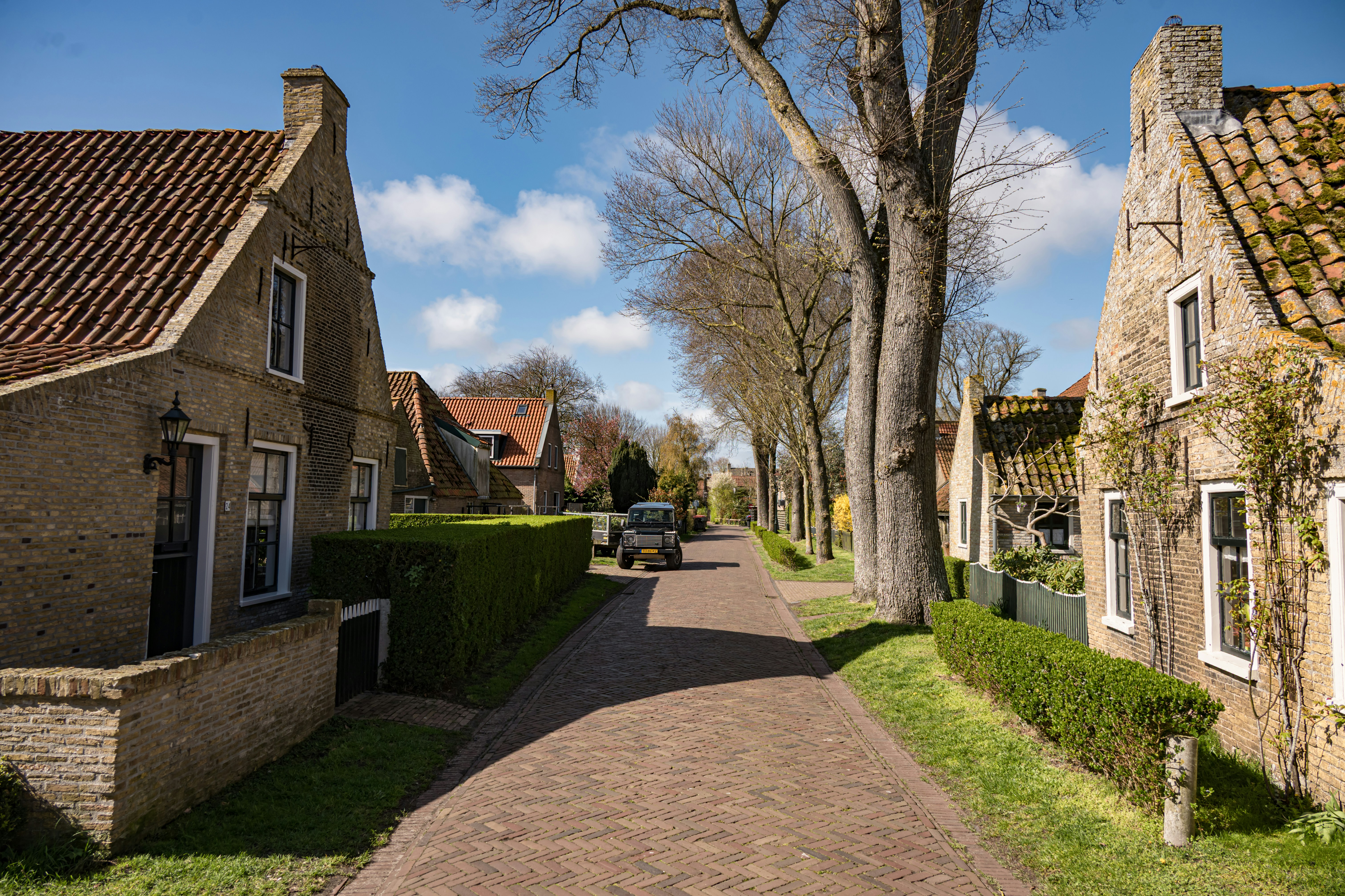 Quiet Dutch-Style Village Lane Framed by Sunlit Brick Cottages