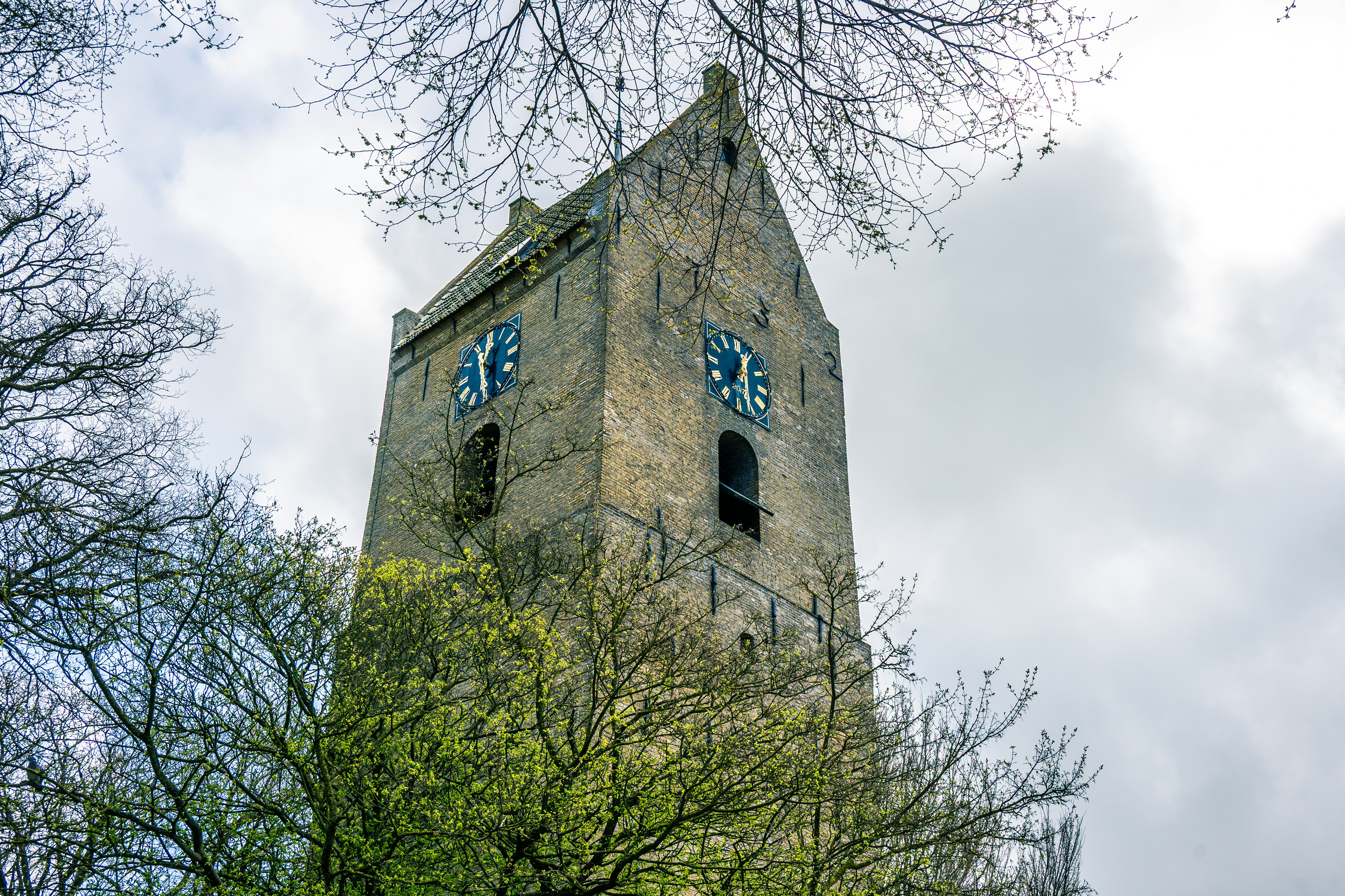 Weathered Clocktower Reaching Toward a Cresting Sky