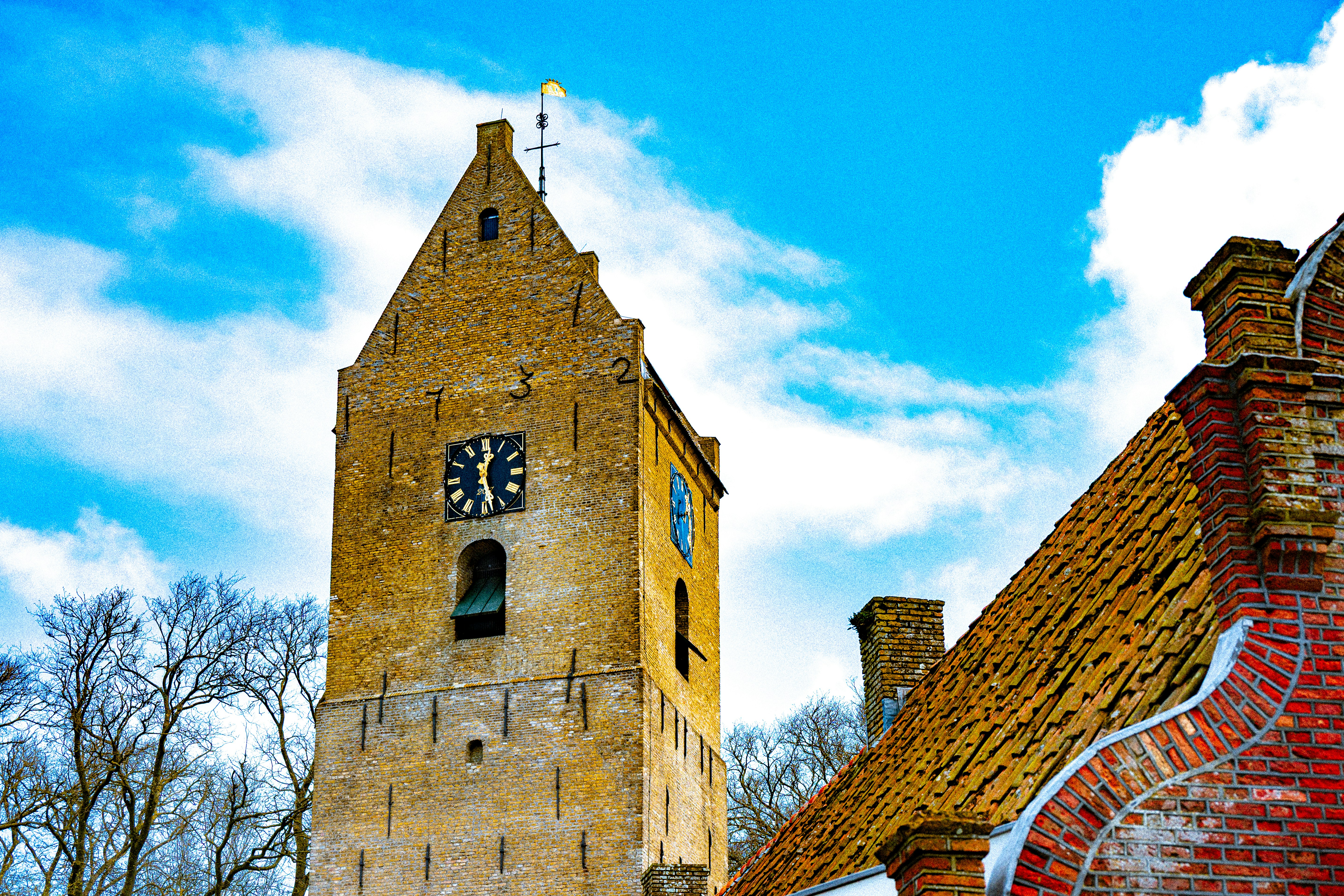 Stone Clocktower Against a Bright Noon Sky
