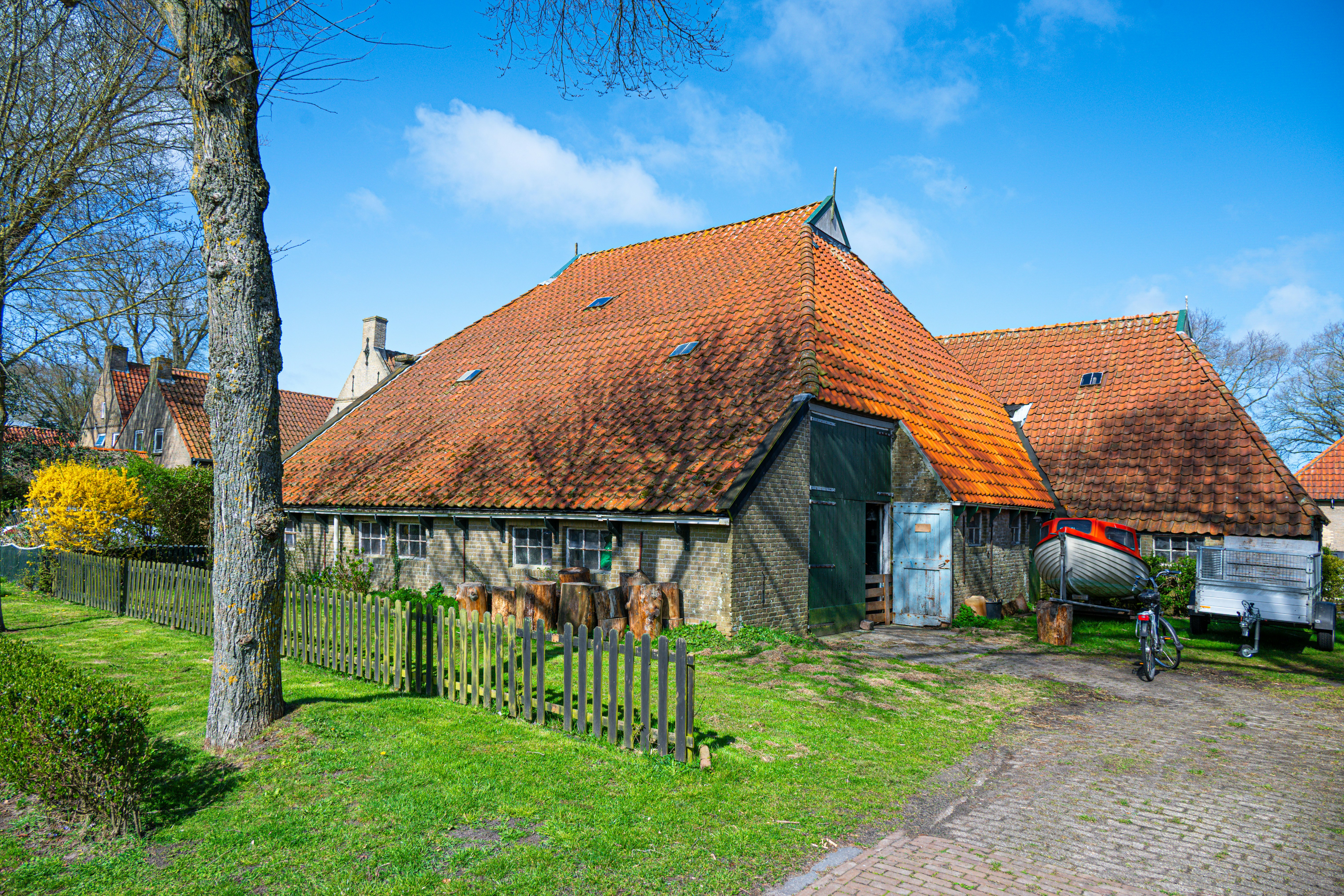 Red-Tiled Farmhouse Under a Bright Dutch Sky